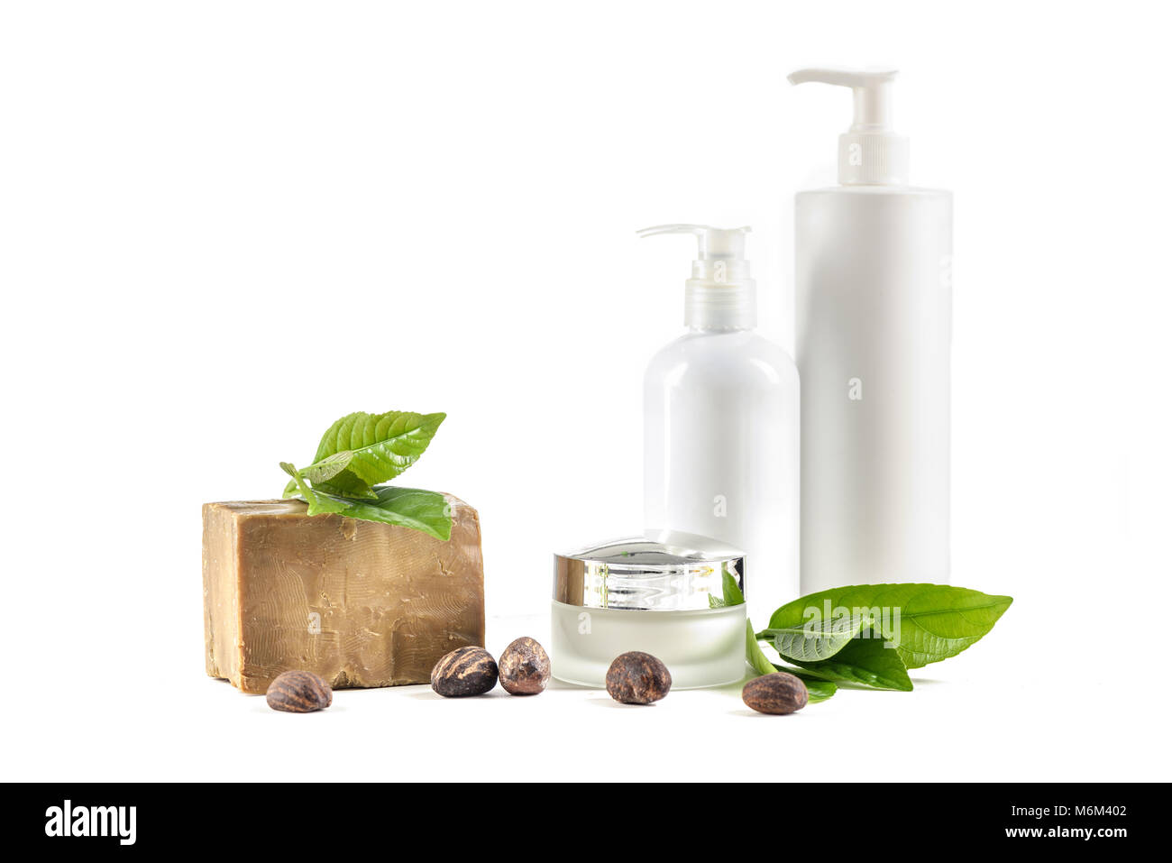 Shea Butter nuts on white with cosmetic products, soap, cream and oil ...
