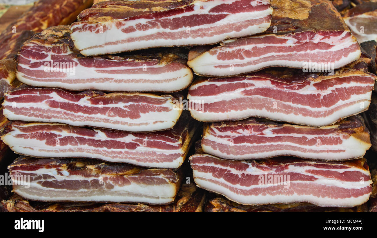 Homemade bacon on the table exposed for sale Stock Photo - Alamy