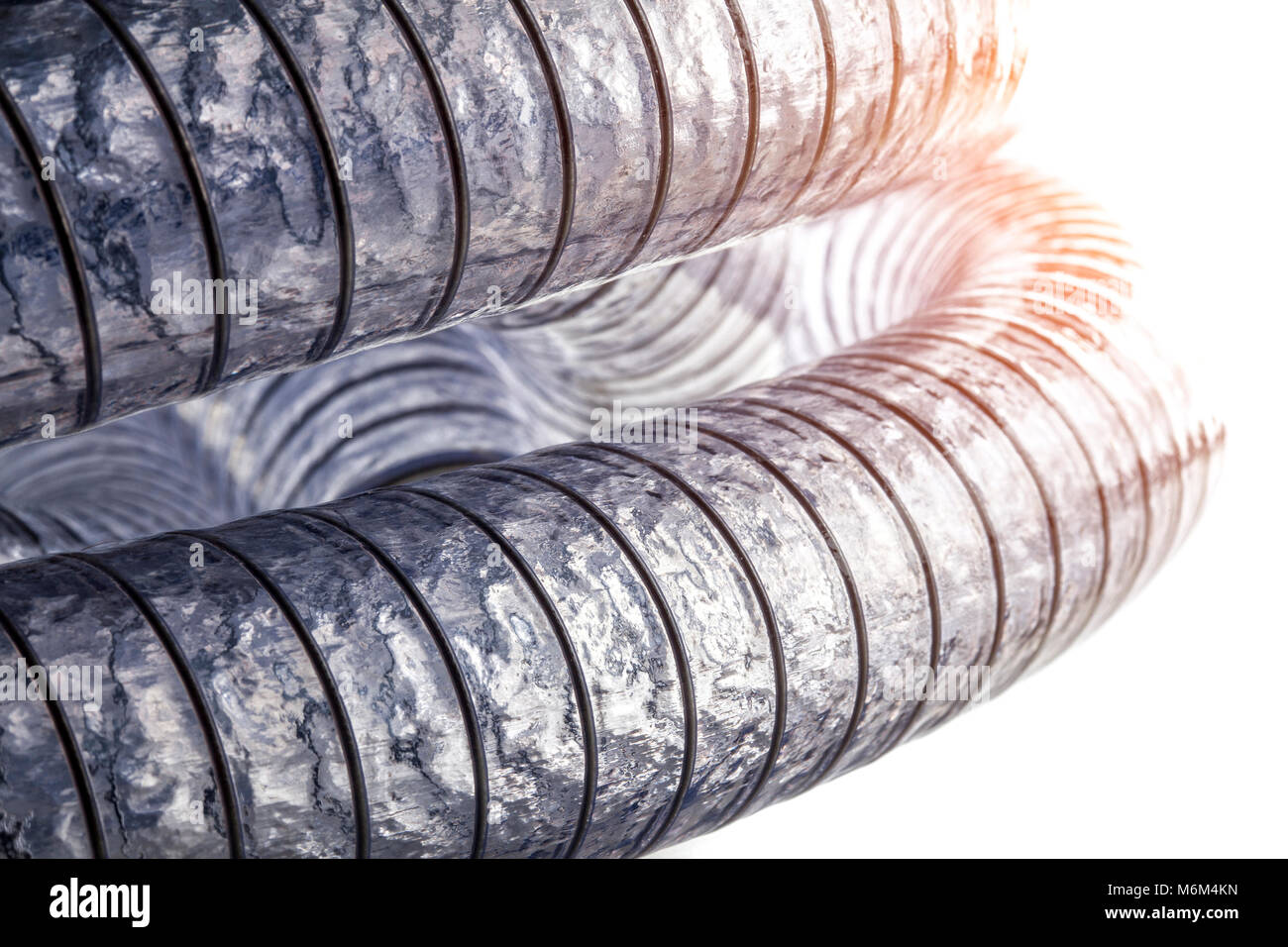 coiled pvc pipe on white background Stock Photo - Alamy
