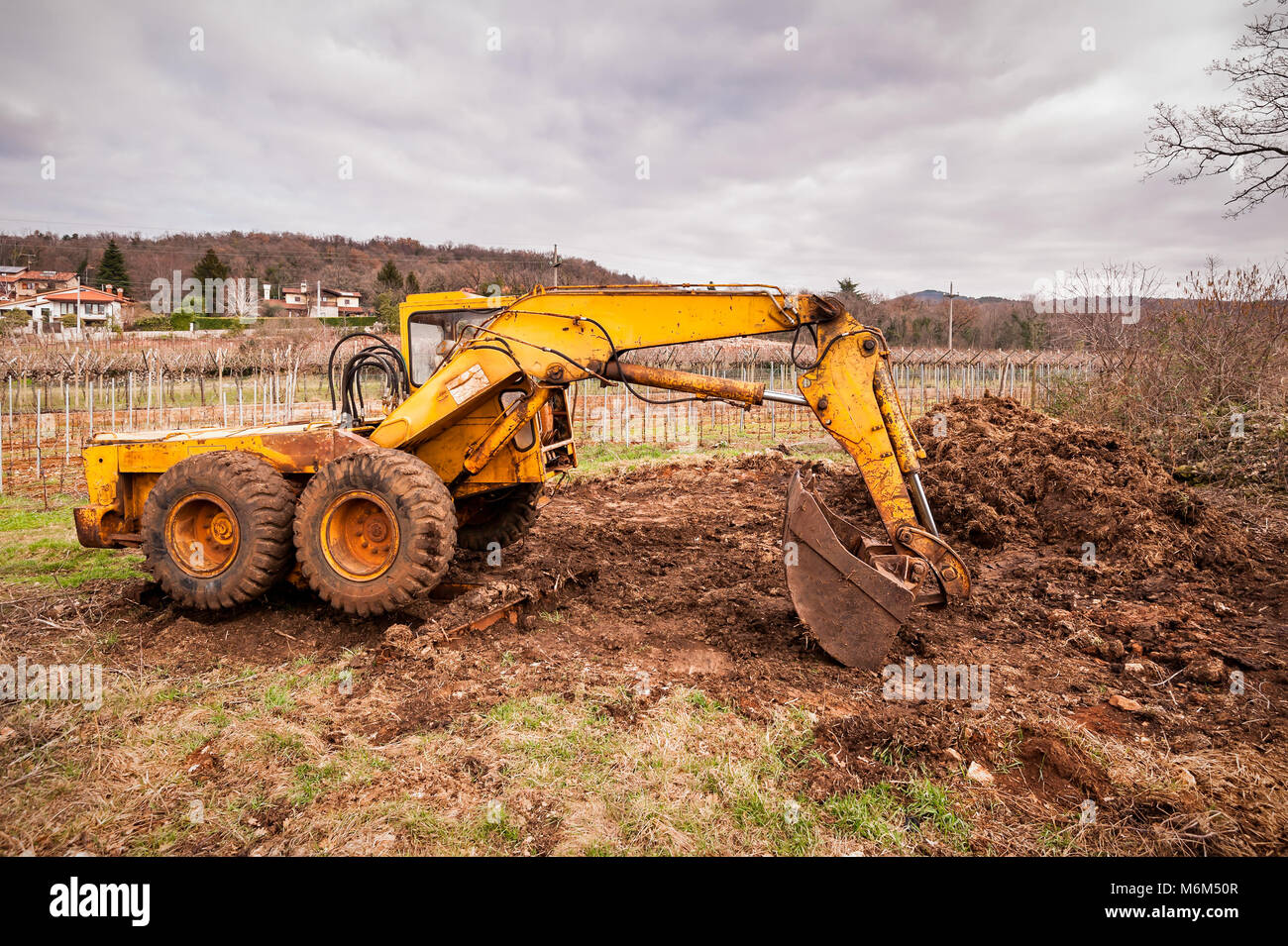 Old digger used to move and load manure in agriculture Stock Photo - Alamy