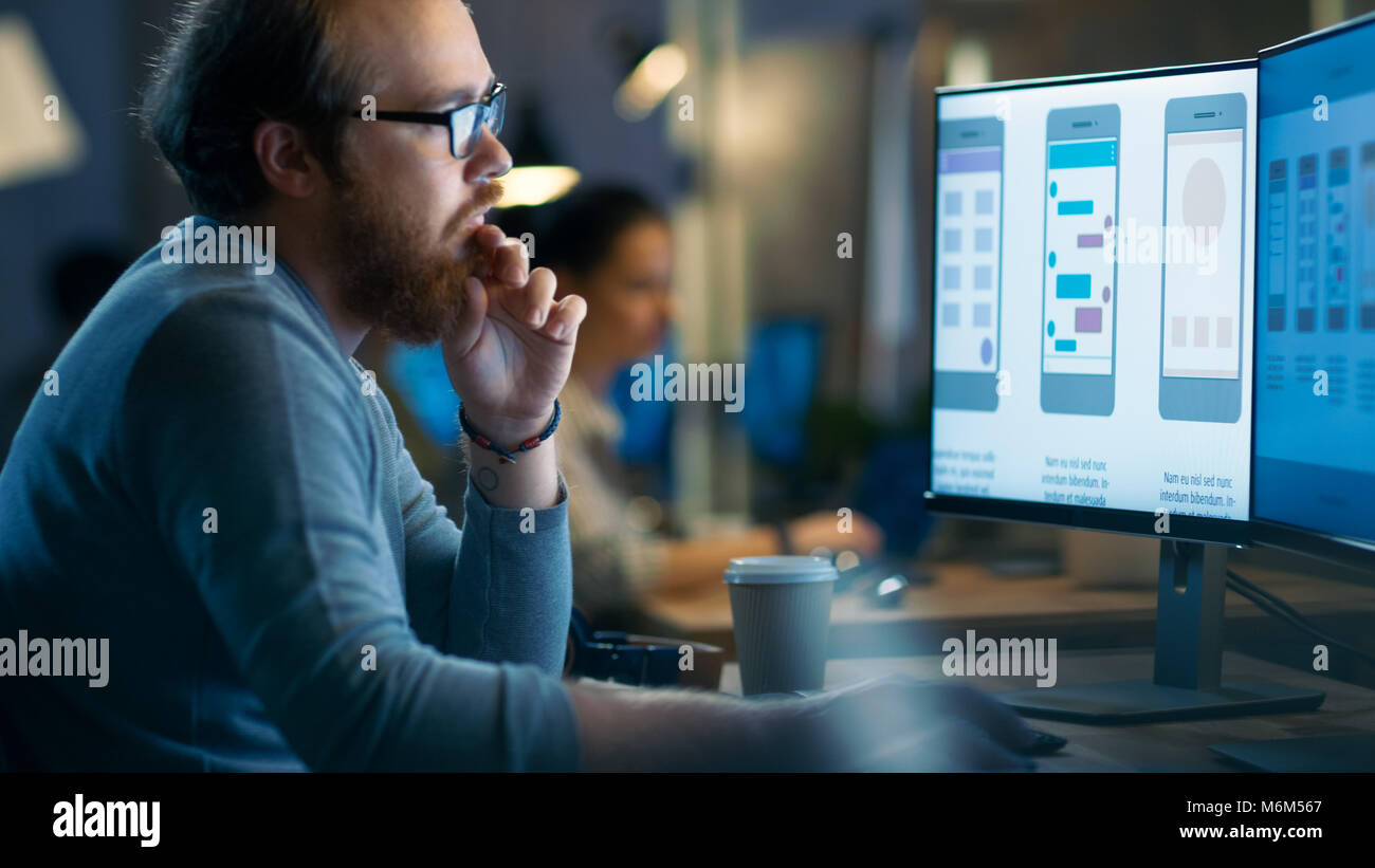 Male Mobile Application Developer Works with Graphics on His Personal ...