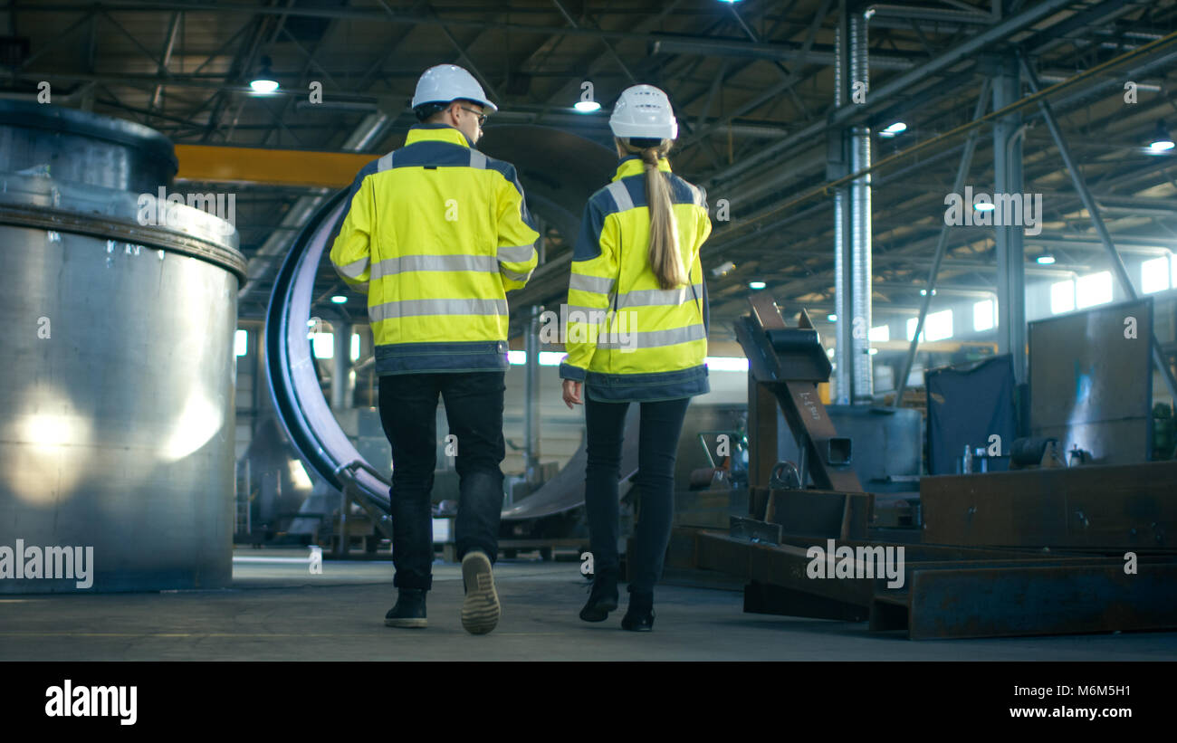 Back View Shot of Male and Female Industrial Engineers Having ...