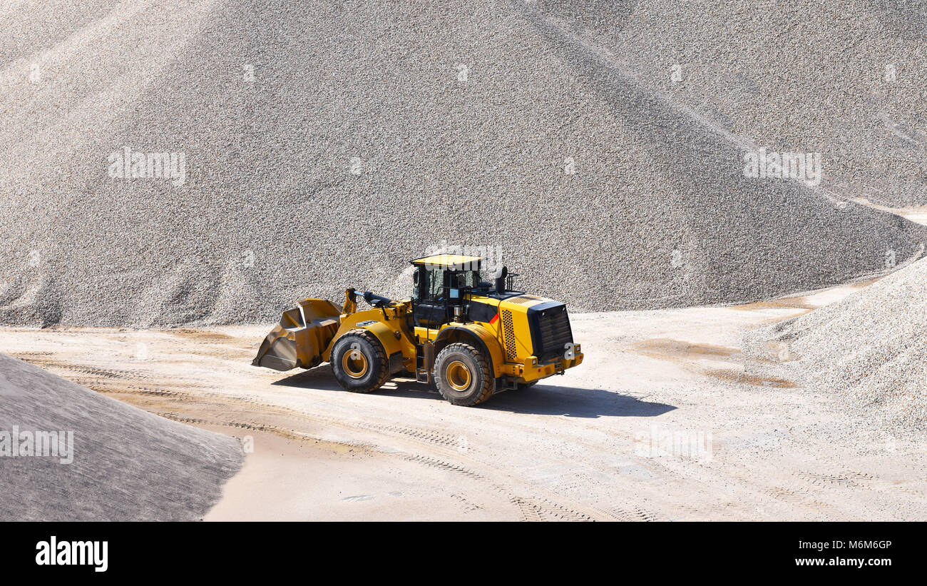 Wheel loader in a gravel pit during mining - heavy construction machine ...