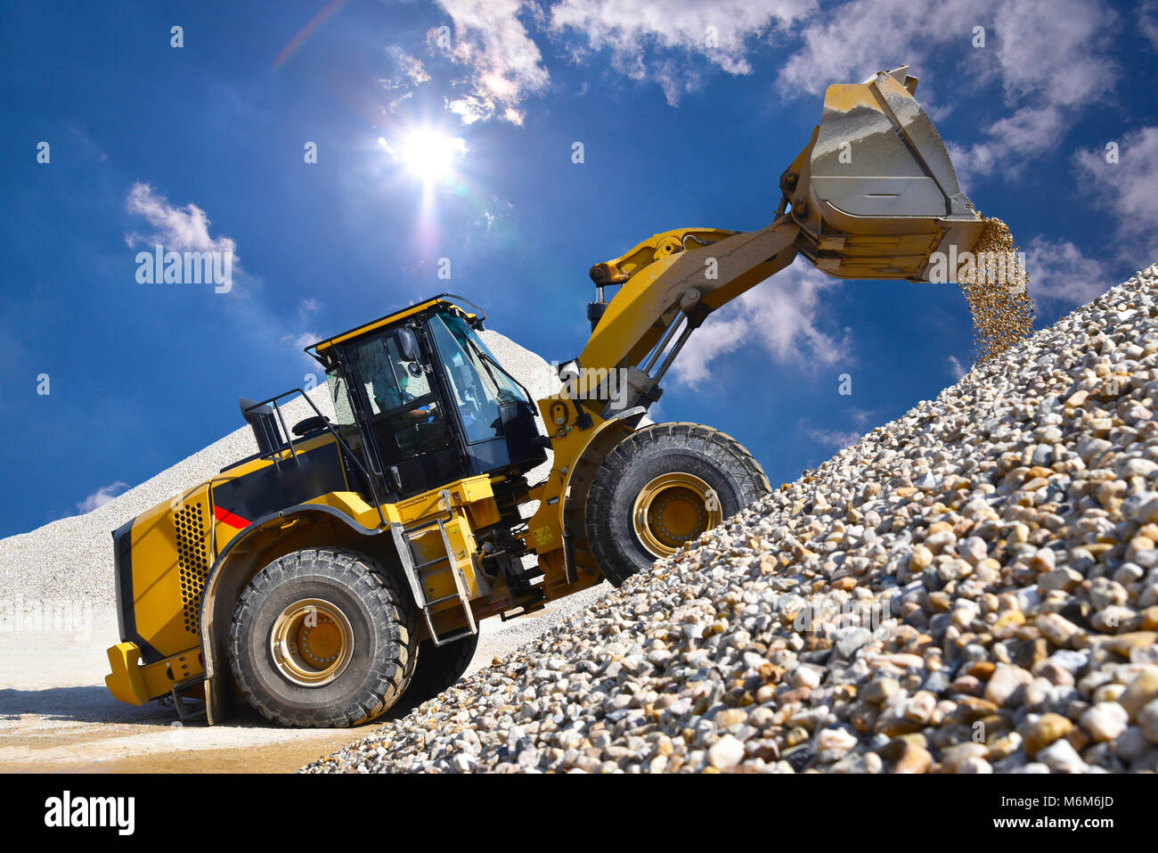 Wheel loader in a gravel pit during mining - heavy construction machine ...