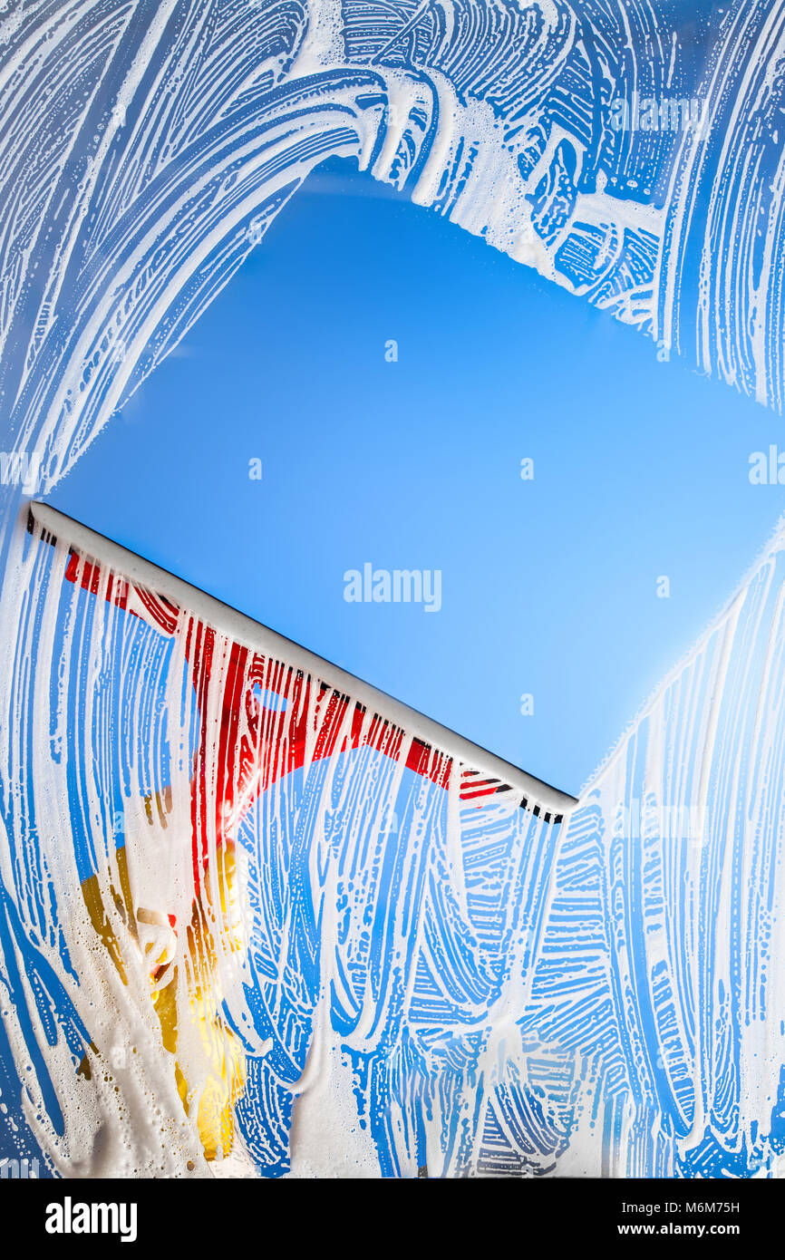 cleaning window with squeegee blue sky Stock Photo - Alamy