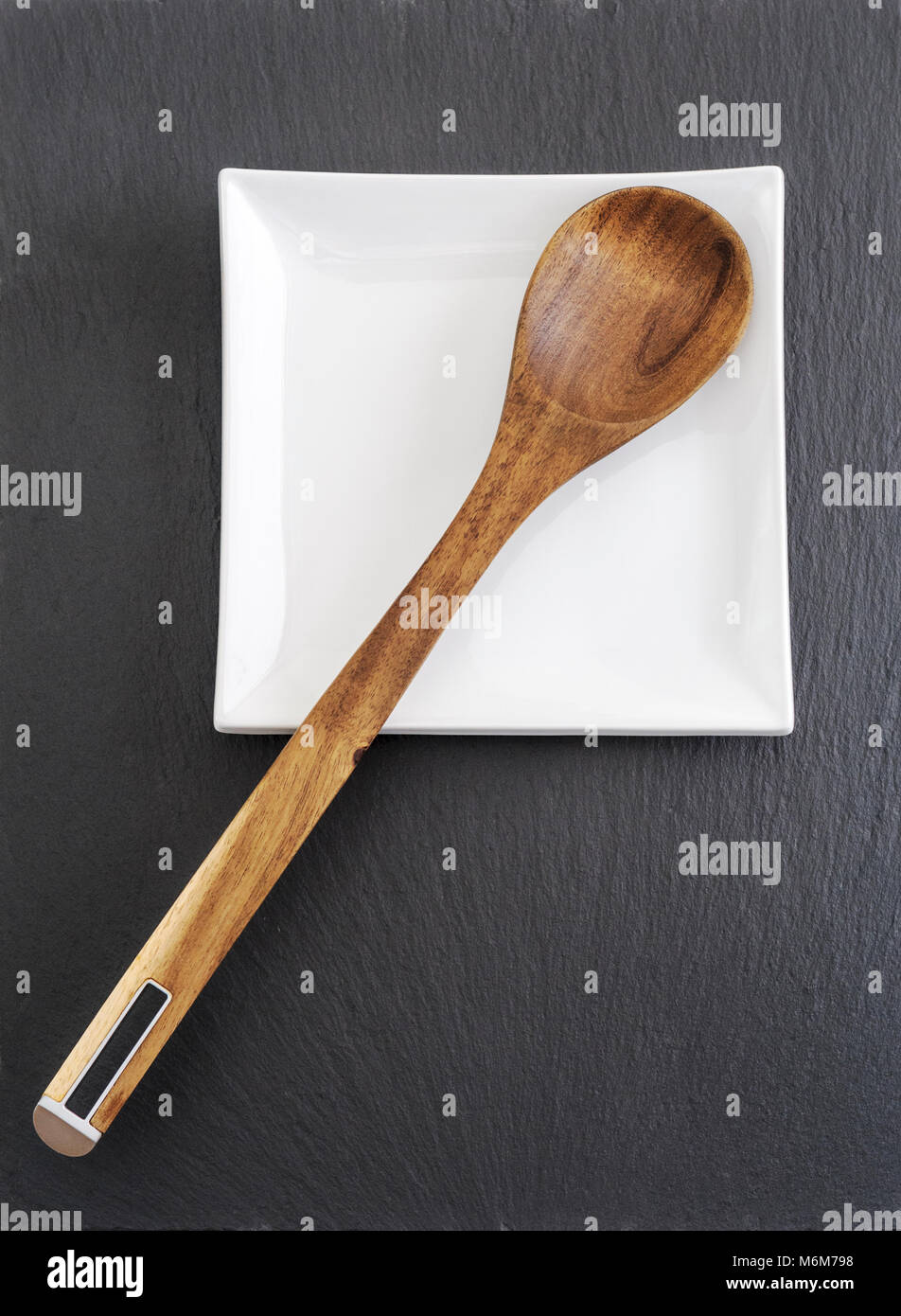 Large rustic serving spoon made of wood, in the middle of a modern ...