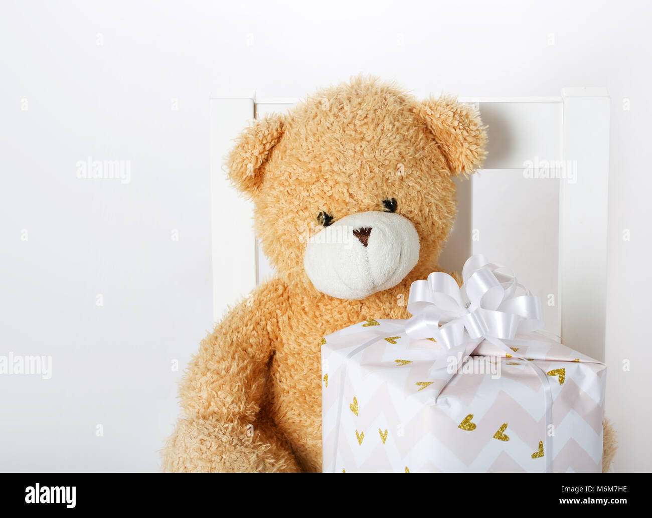 Plush teddy bear with presents on gray background. Closeup Stock Photo ...
