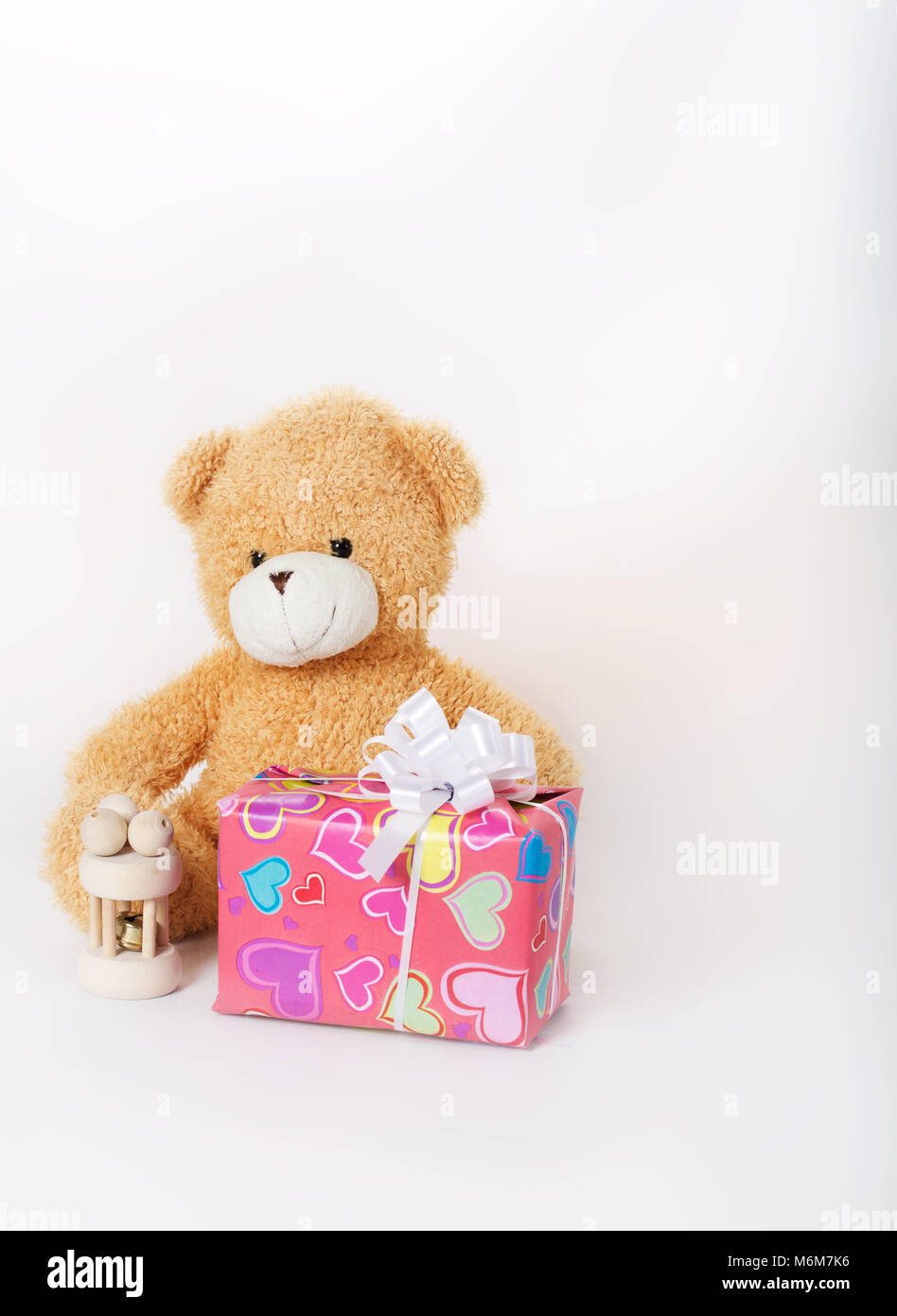 Plush teddy bear with presents on gray background. Closeup Stock Photo ...