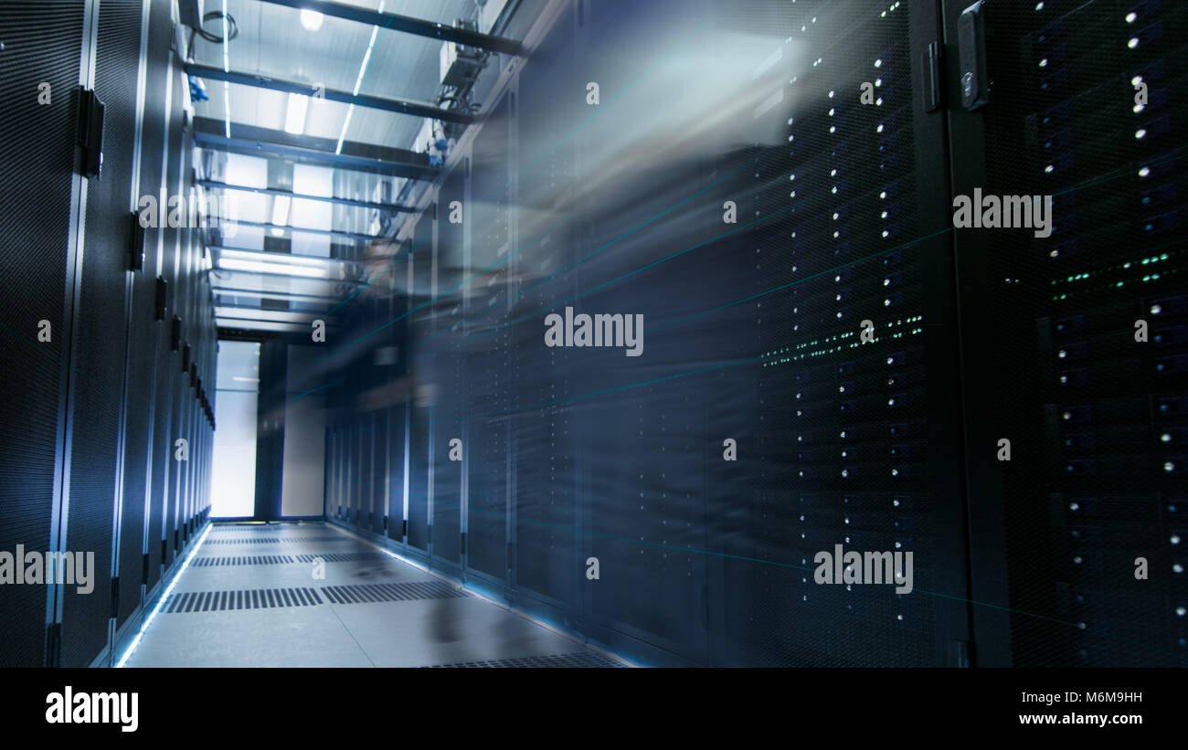Shot of a Working Data Center With Rows of Rack Servers. People Walk ...