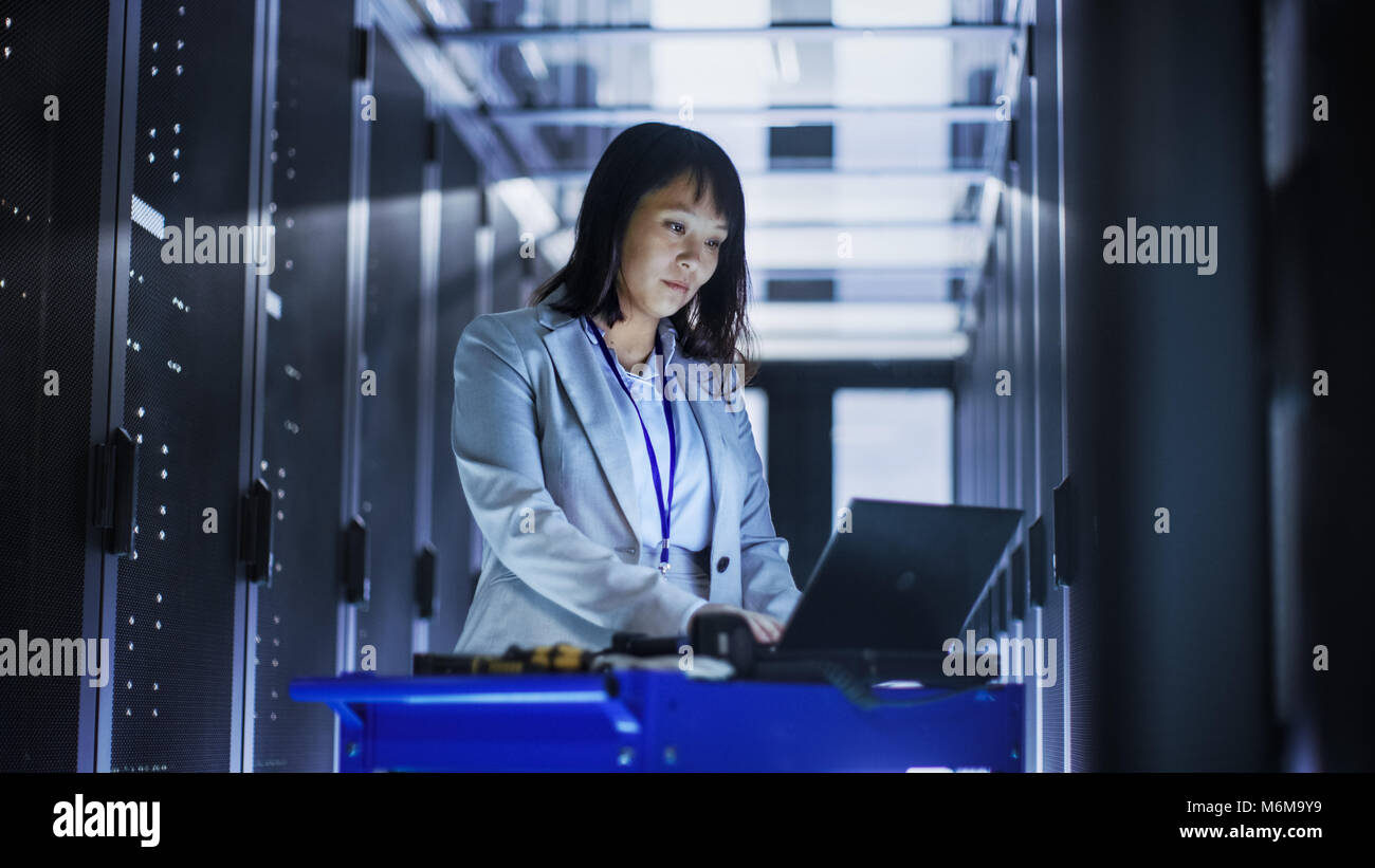 Asian Female IT Engineer Working on a Laptop on Tool Cart, She Scans ...