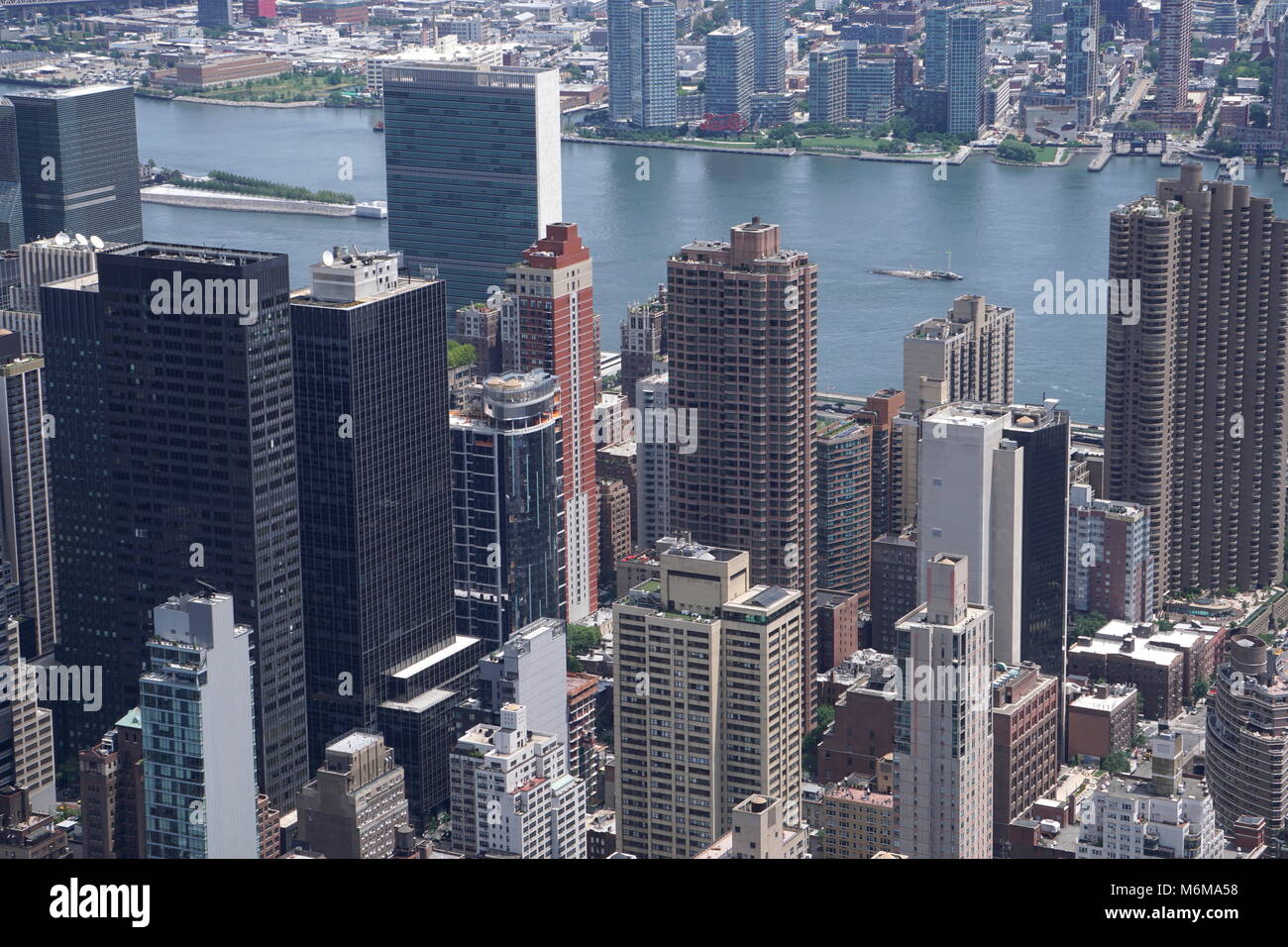 Aerial establishing photo of buildings rooftops in New York City on a ...