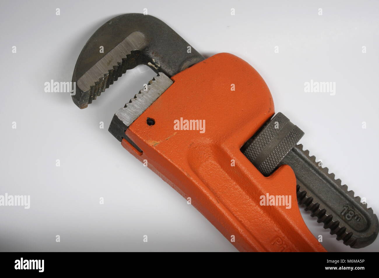 Isolated large plumbers pipe wrench on a white background. Used for ...