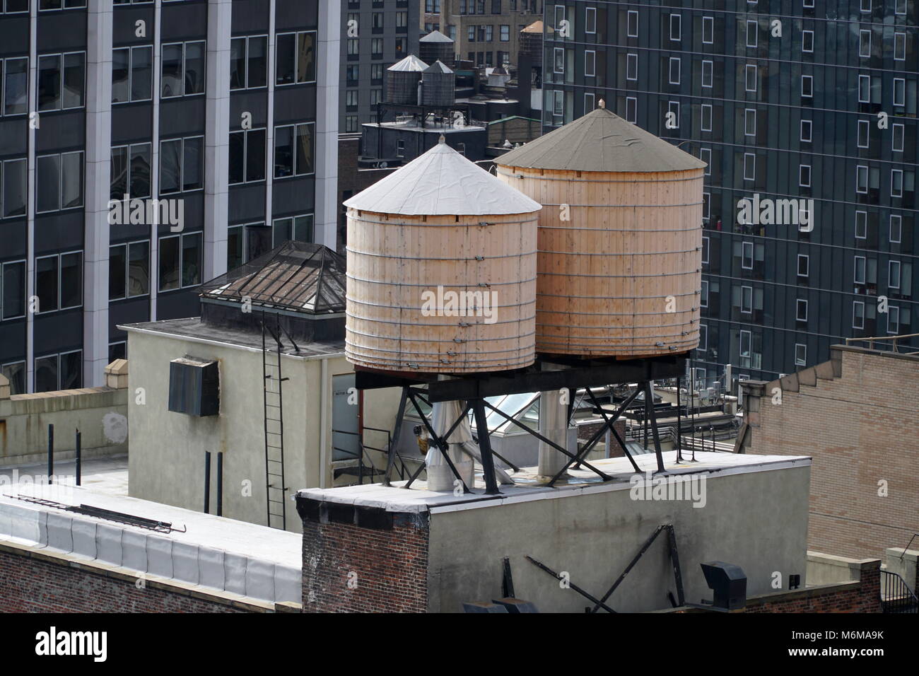 Water tower collection tanks on rooftops of New York City apartment ...