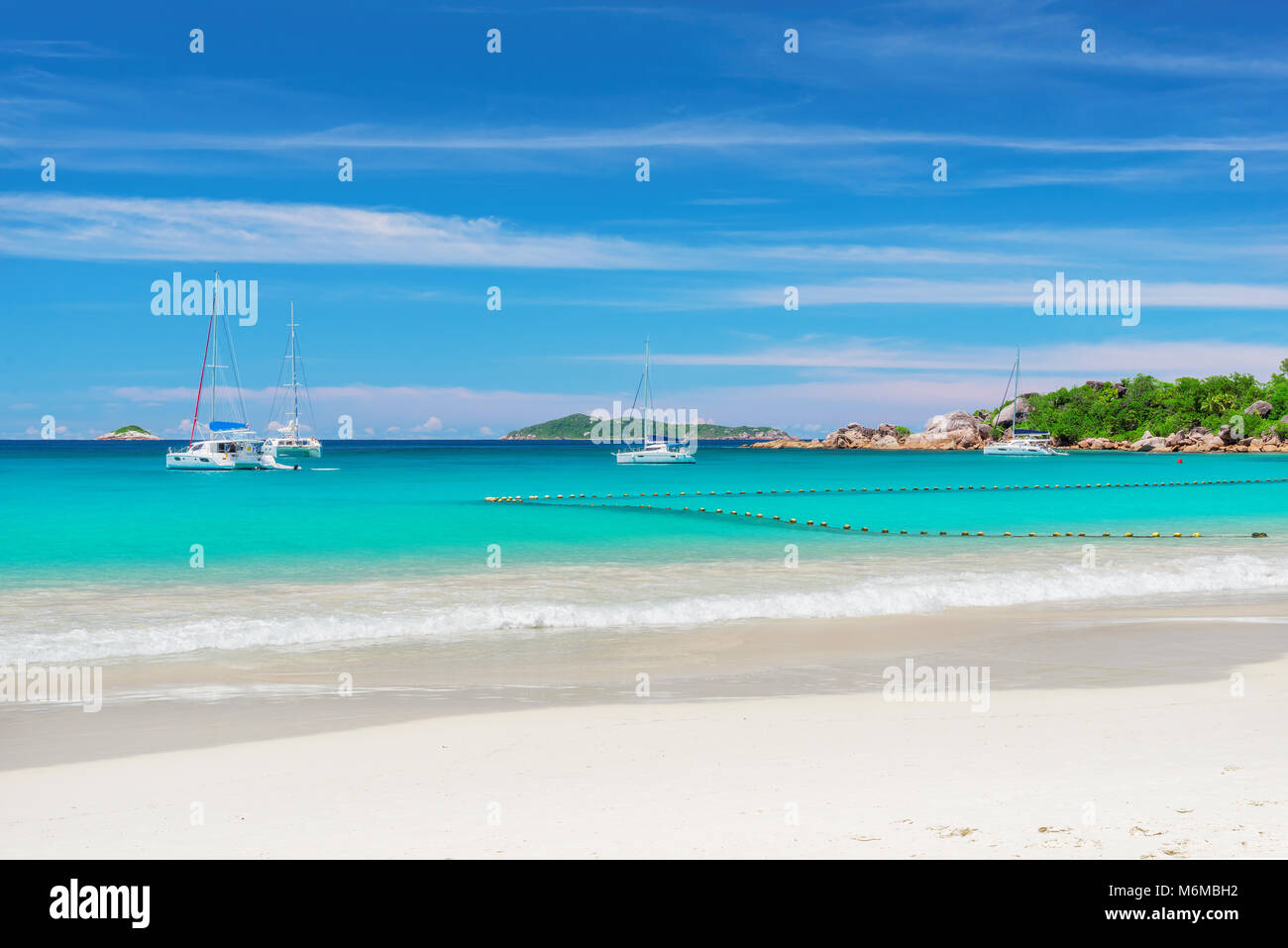 Tropical beach with sailing boats in the sea Stock Photo - Alamy