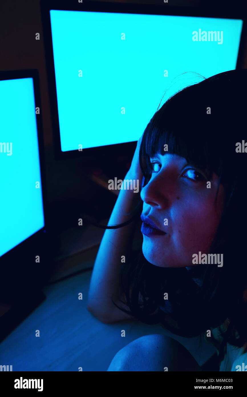 Young woman using her computer at night in her room Stock Photo - Alamy