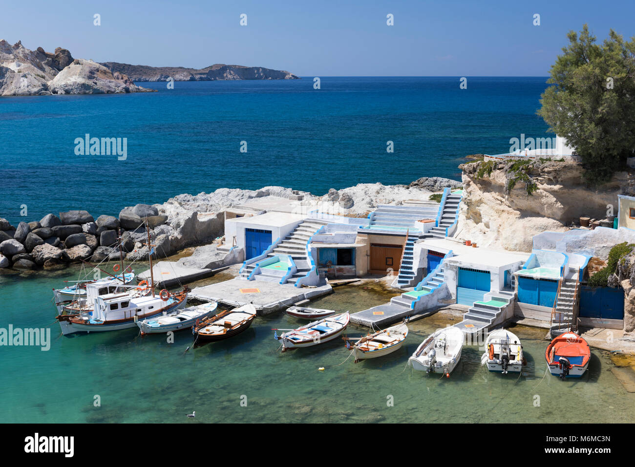 View over fishing harbour with boats and colourful boat houses ...