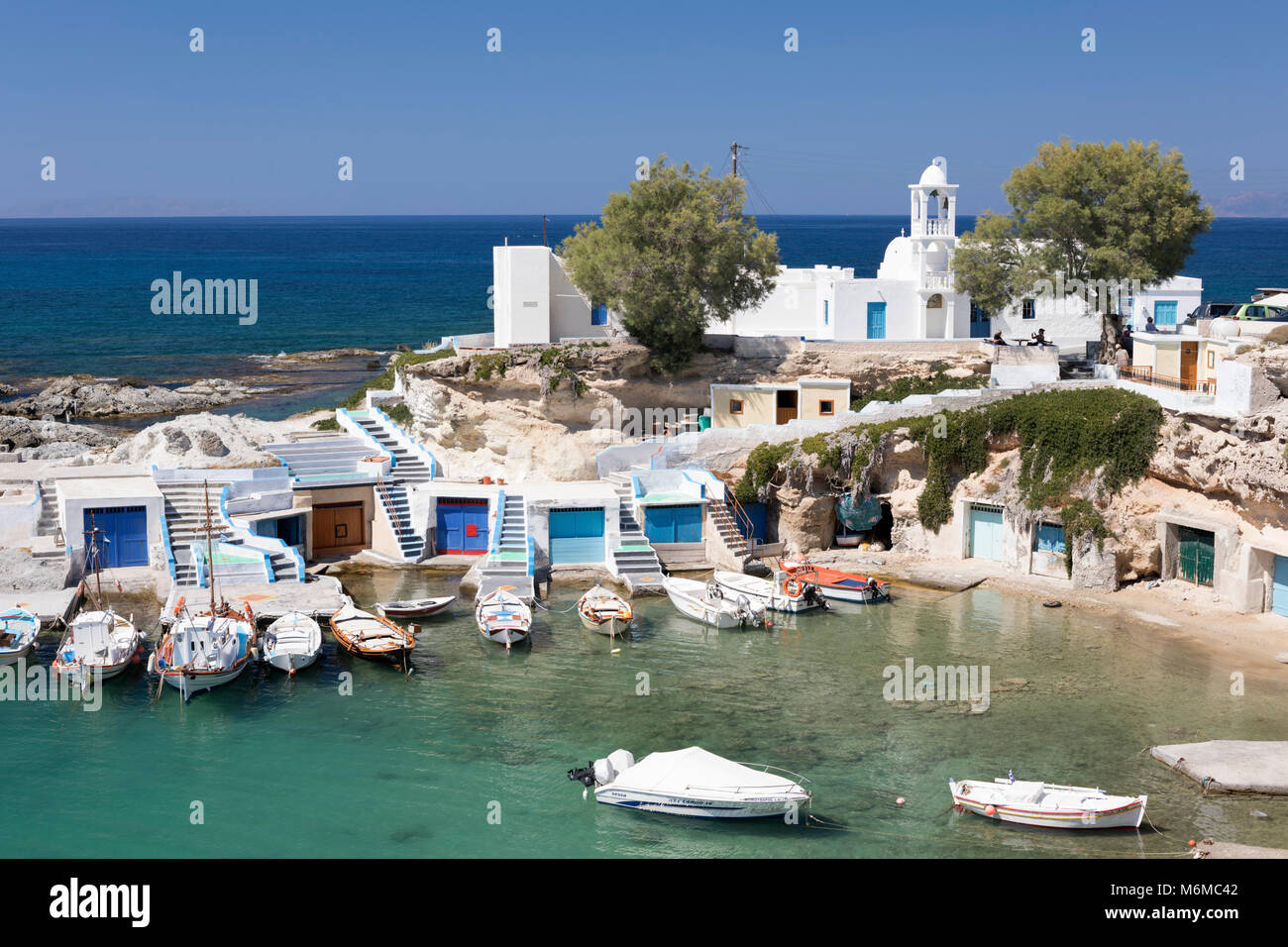 View over fishing harbour with boats and colourful boat houses ...