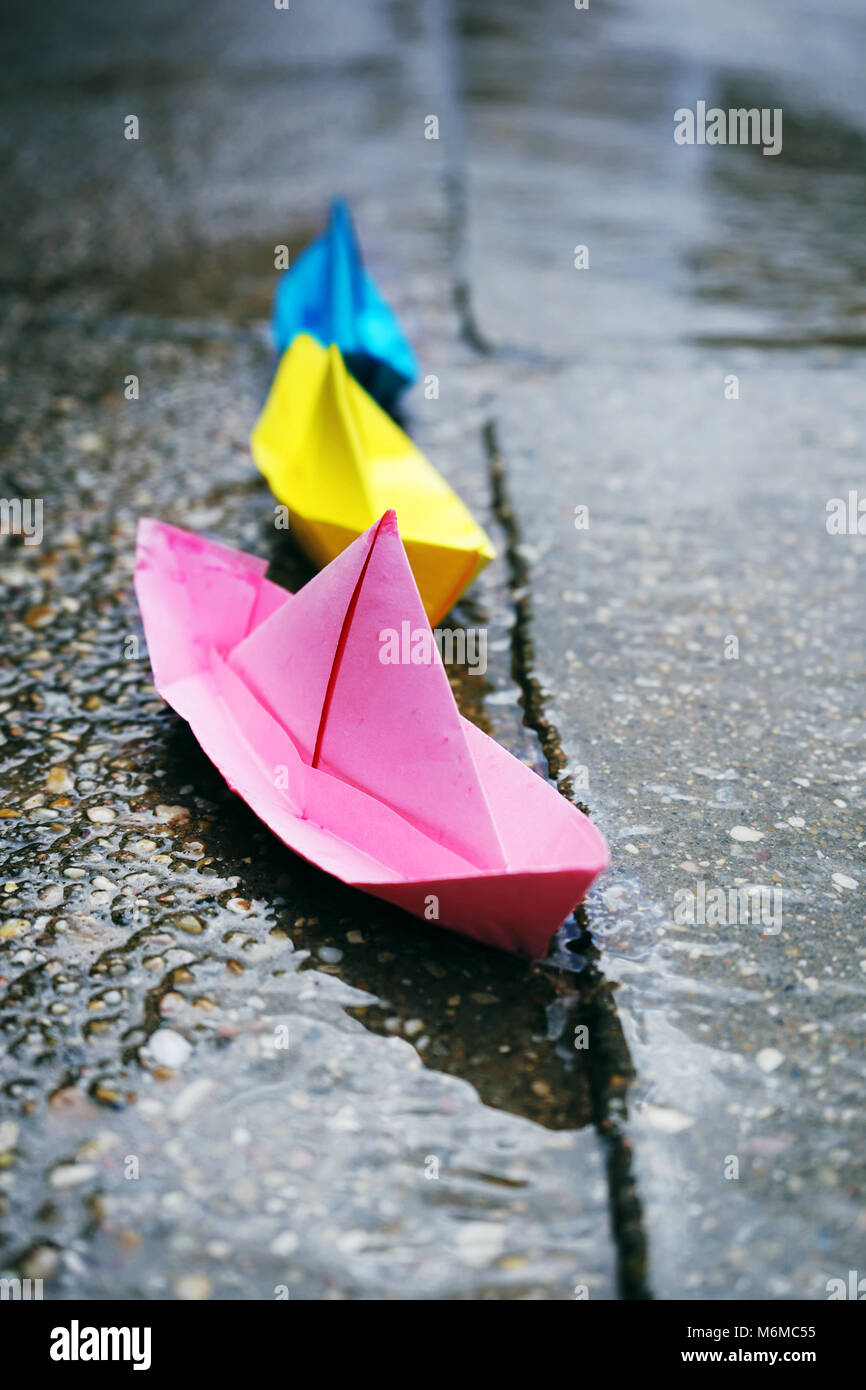 Paper boats in rain water hi-res stock photography and images - Alamy