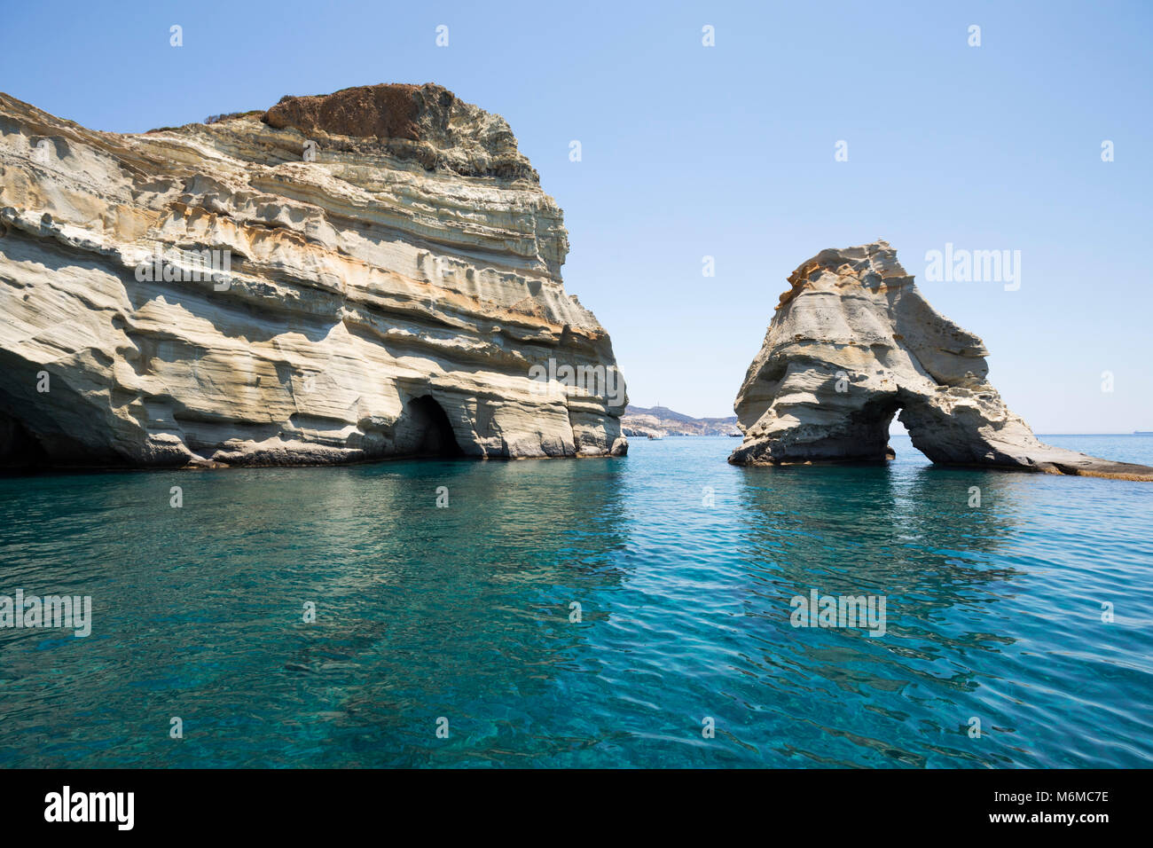Sea caves and rock formations with crystal clear water at Kleftiko ...