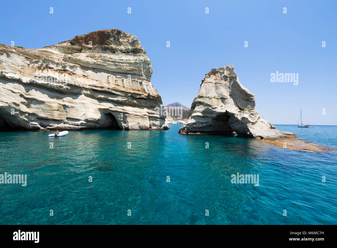 Sea caves and rock formations with crystal clear water at Kleftiko ...
