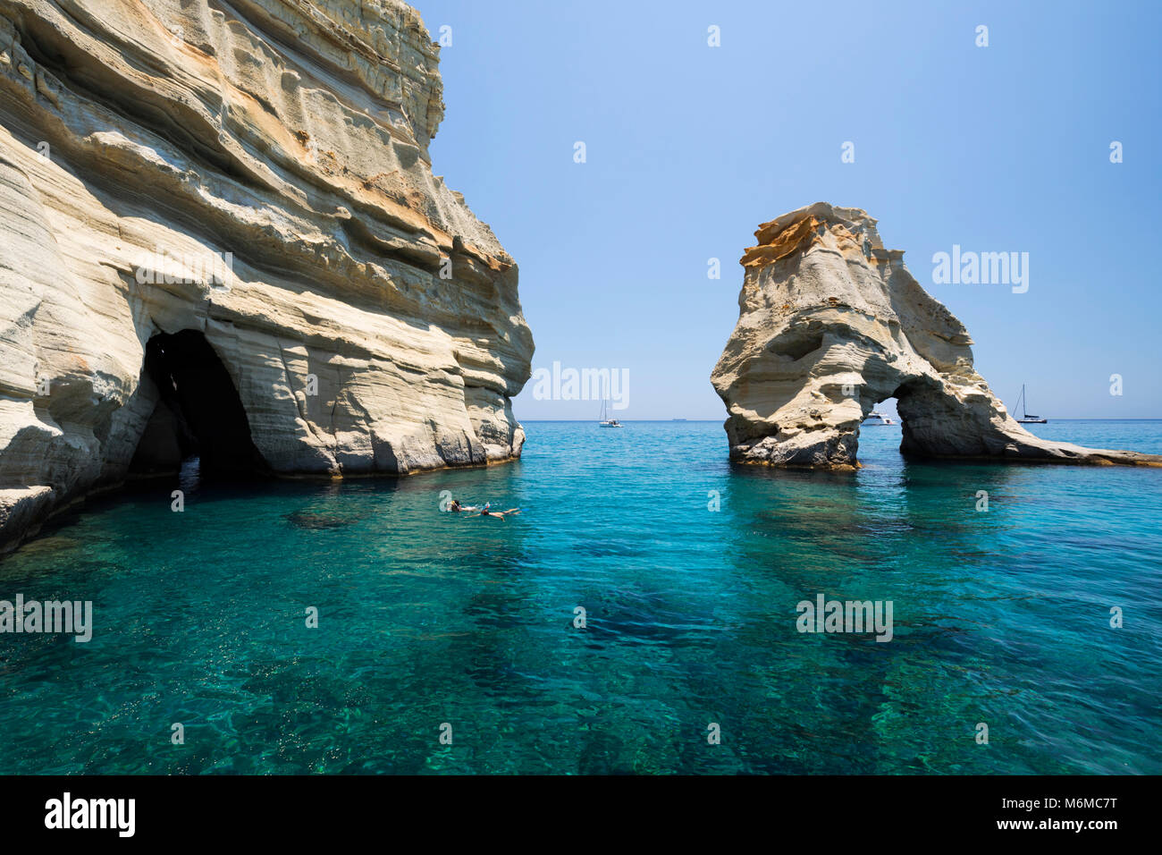 Sea caves and rock formations with crystal clear water at Kleftiko ...