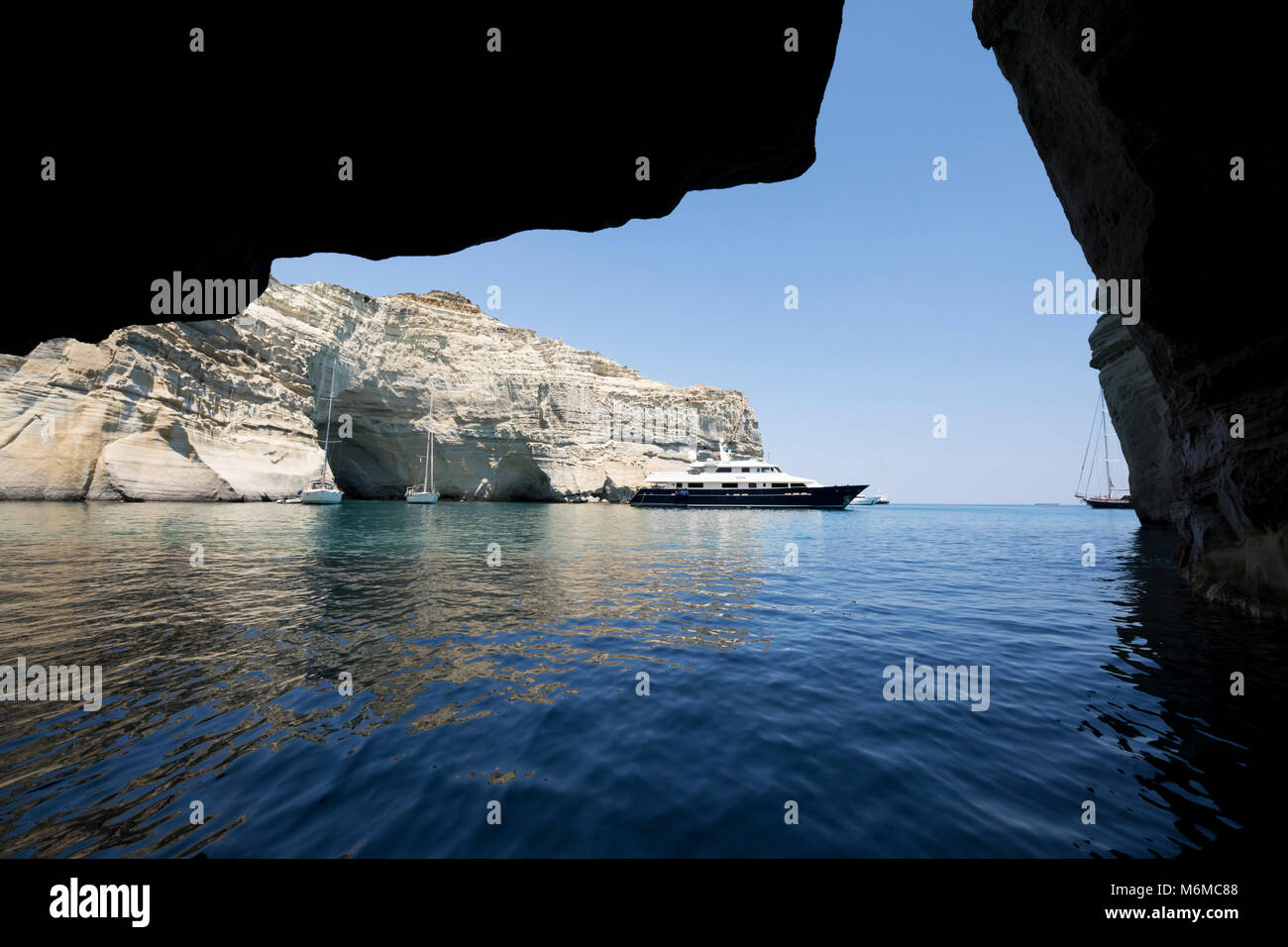Sea caves and rock formations with crystal clear water at Kleftiko ...