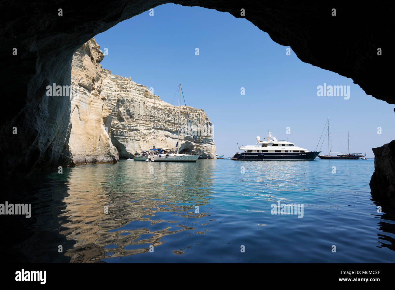 Sea caves and rock formations with crystal clear water at Kleftiko ...