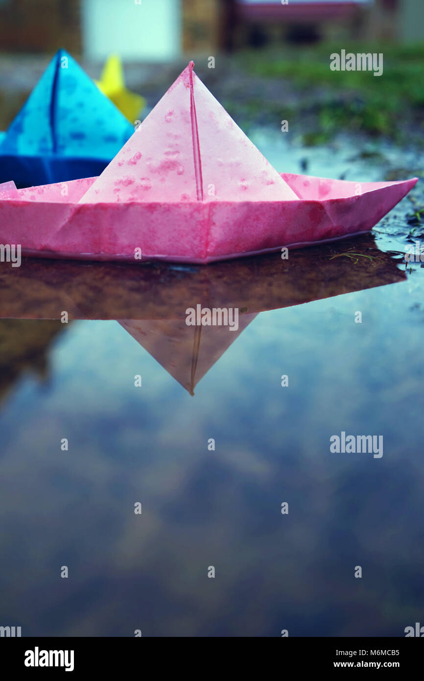 Color paper boats in a rainy day Stock Photo - Alamy