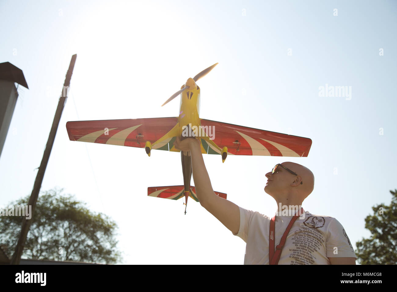 Boy with model aircraft, in a country landscape, in the south of Italy ...