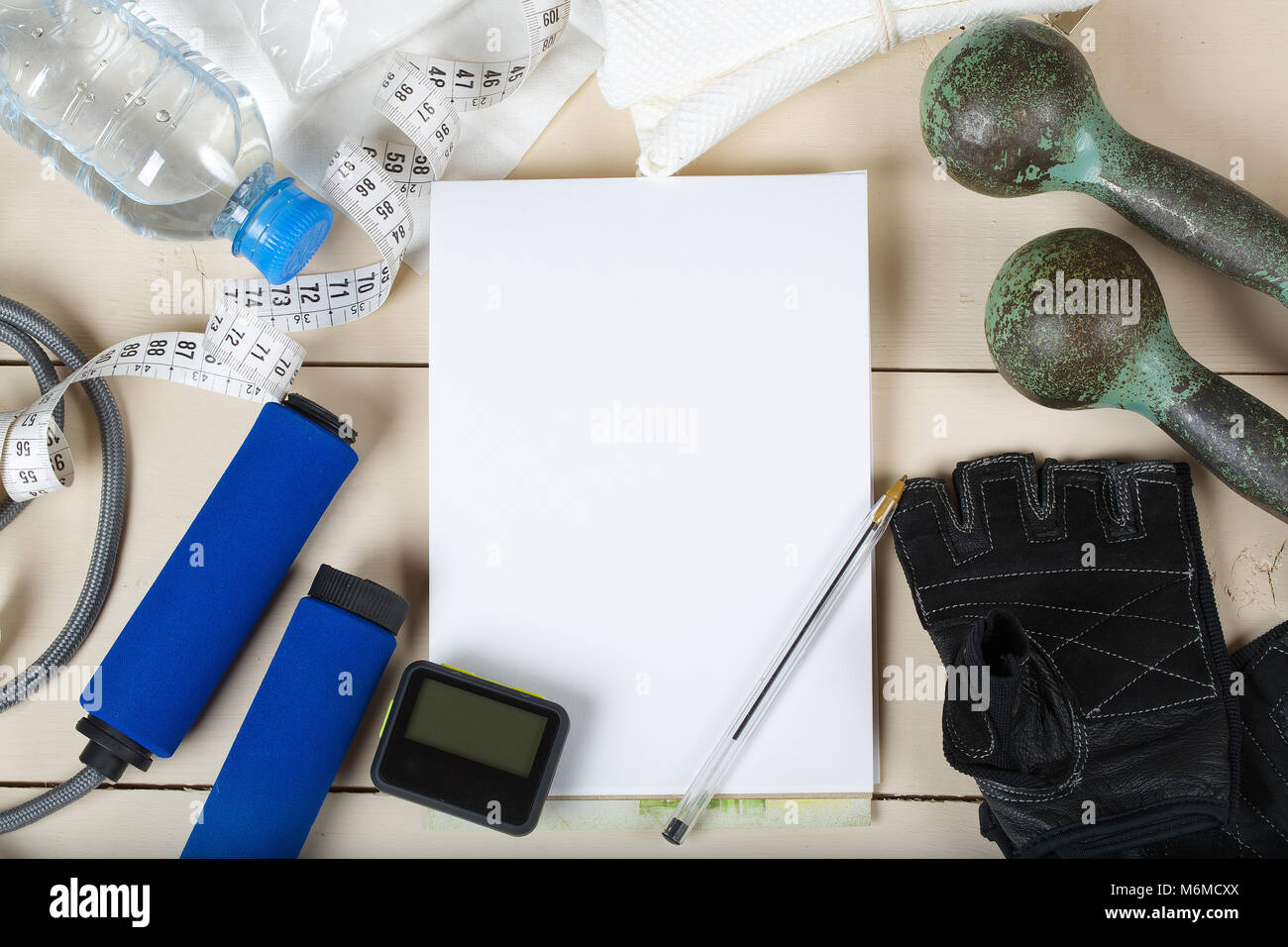 Fitness plan background: copybook,interval timer,jumping rope,water ...