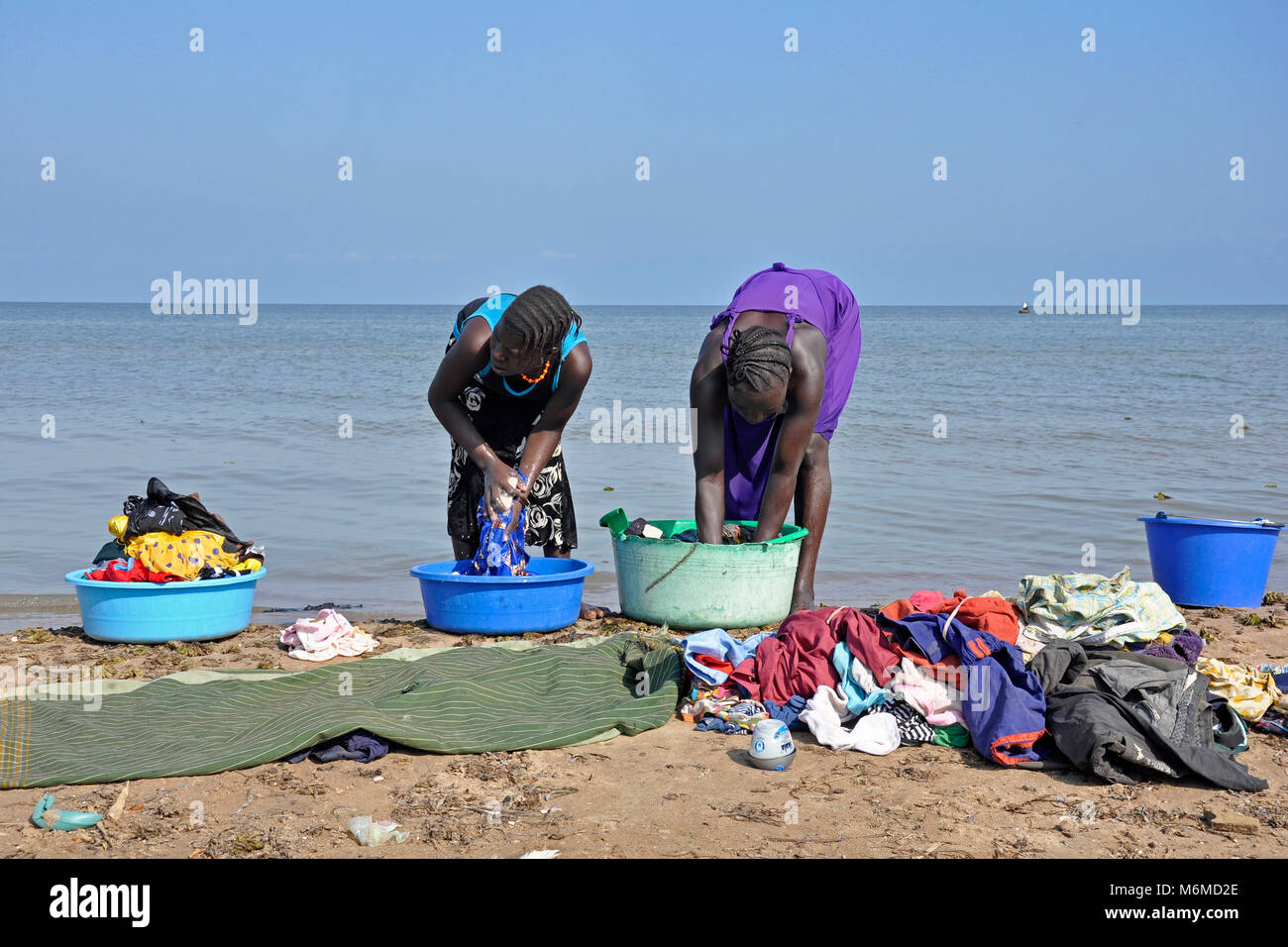 Uganda, Rift Valley, Butiada Village, Woman washing clothes Stock Photo ...