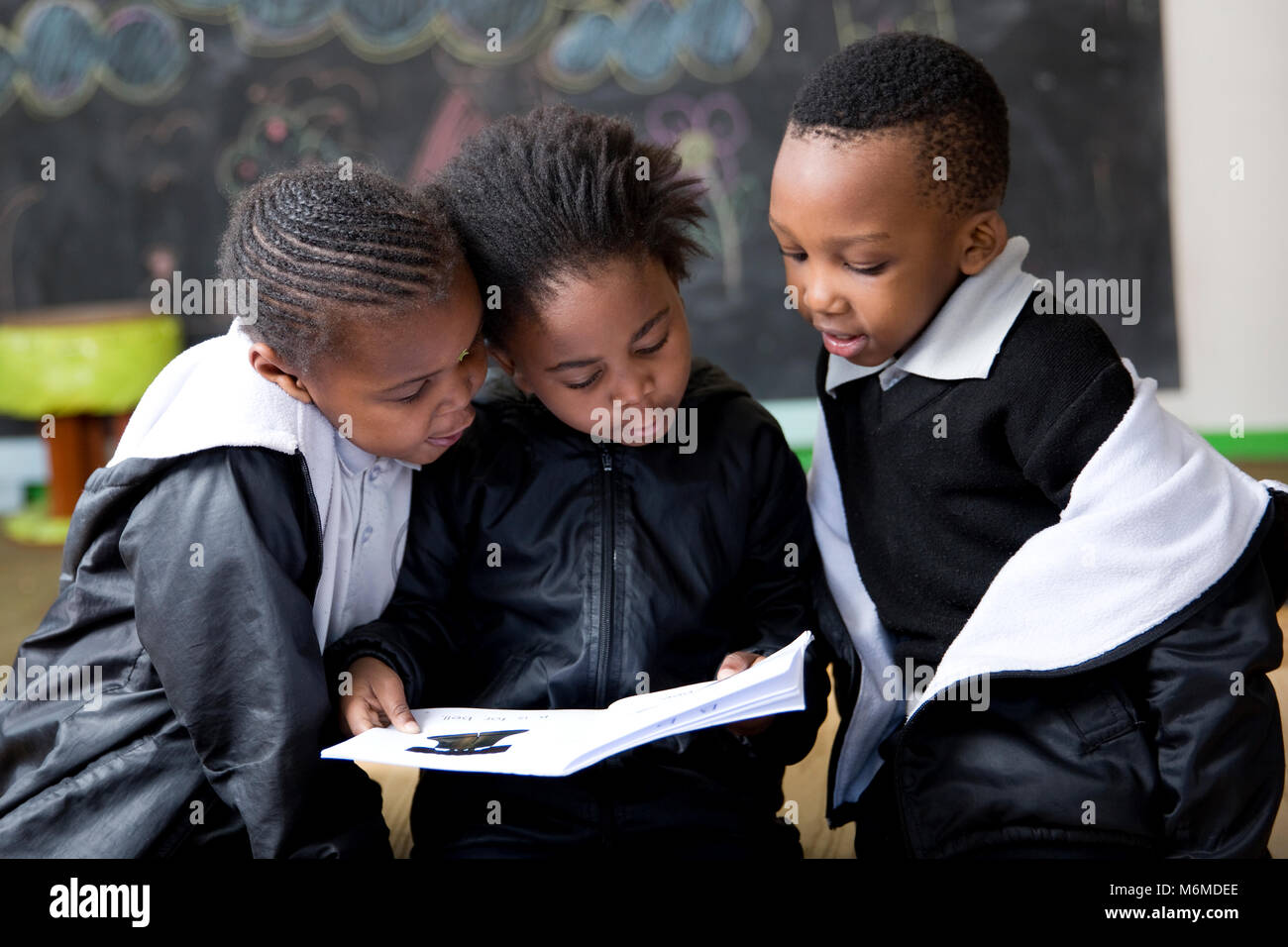 School kids reading in the classroom Stock Photo - Alamy