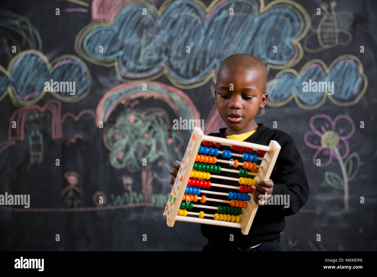 A boy counting on abacus Stock Photo - Alamy