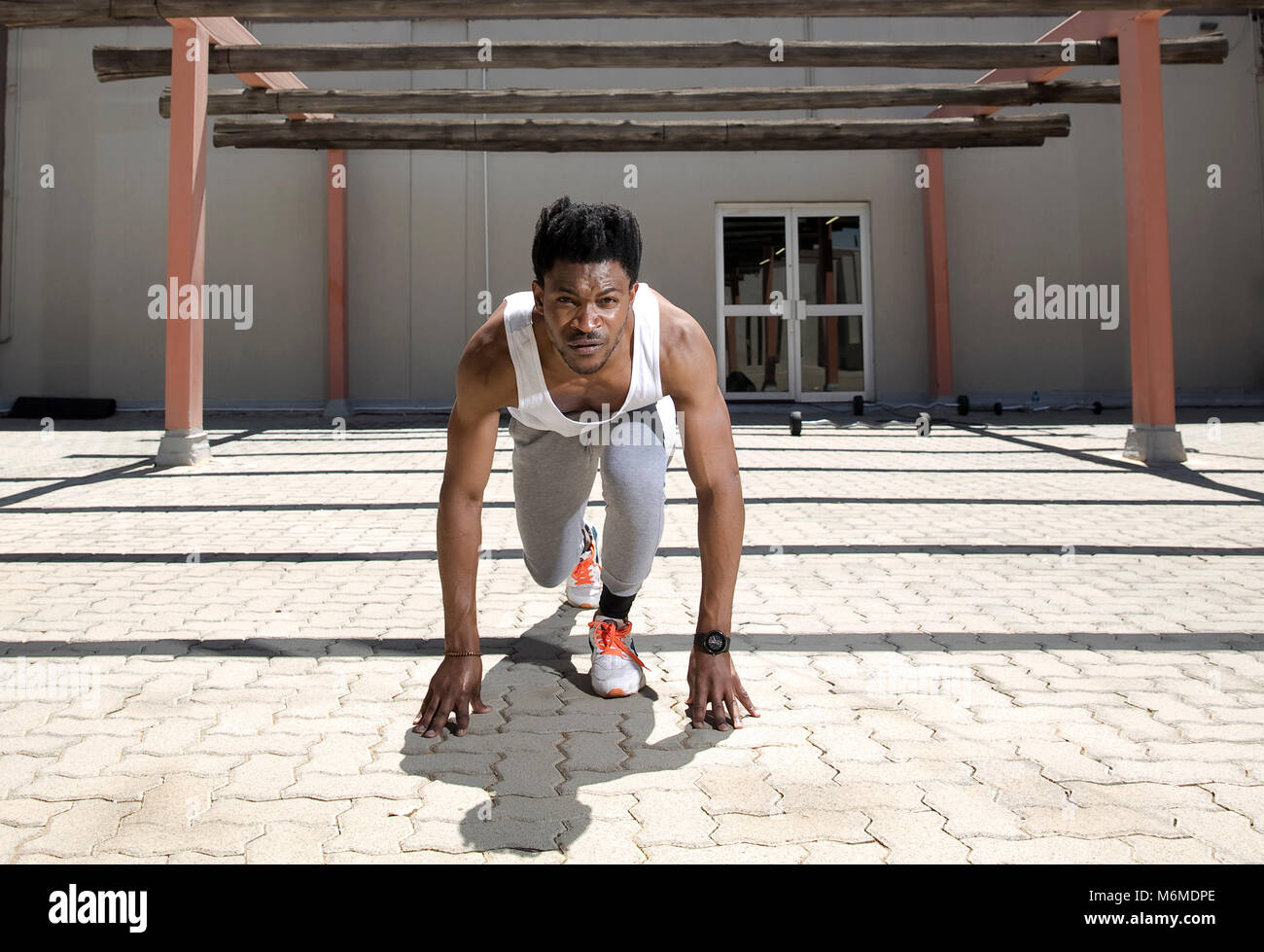 Athlete preparing to run in the gym Stock Photo - Alamy