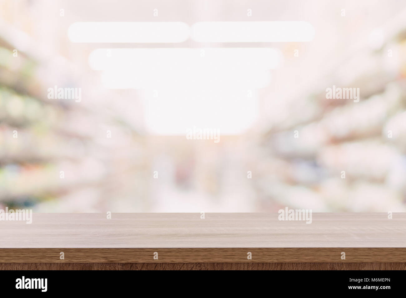 Empty wooden table top with blurred modern shopping mall background for ...