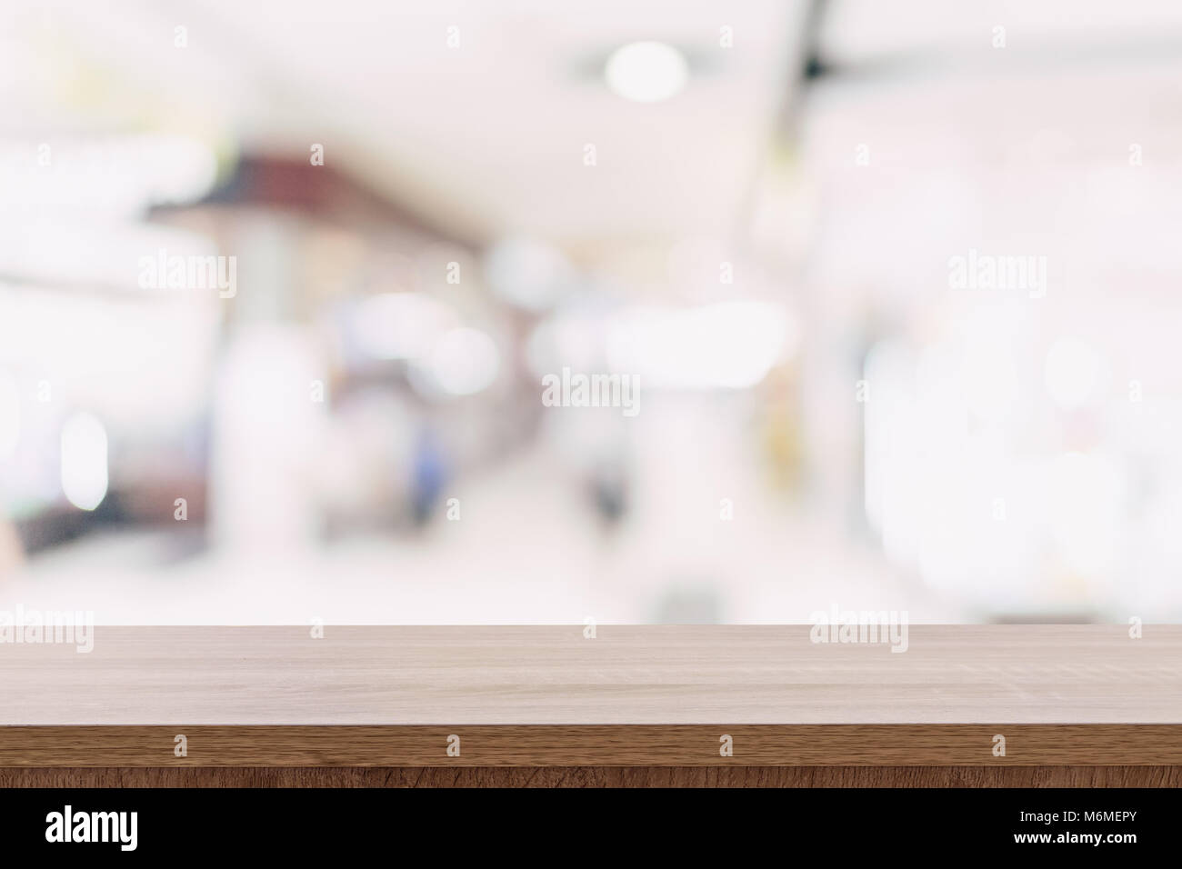 Empty wooden table top with blurred modern shopping mall background for ...