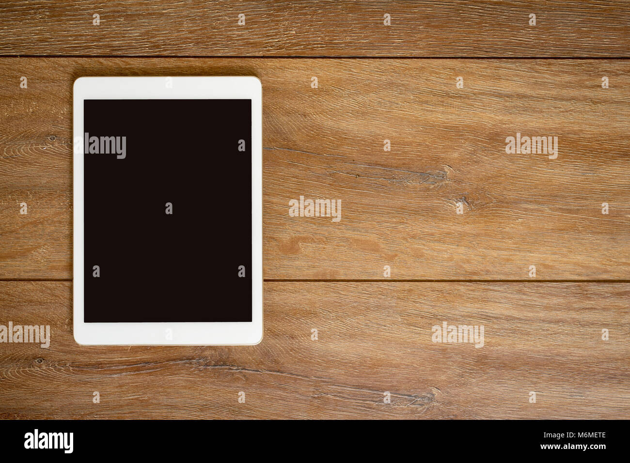 Blank Tablet computer on wood table background with space for text ...