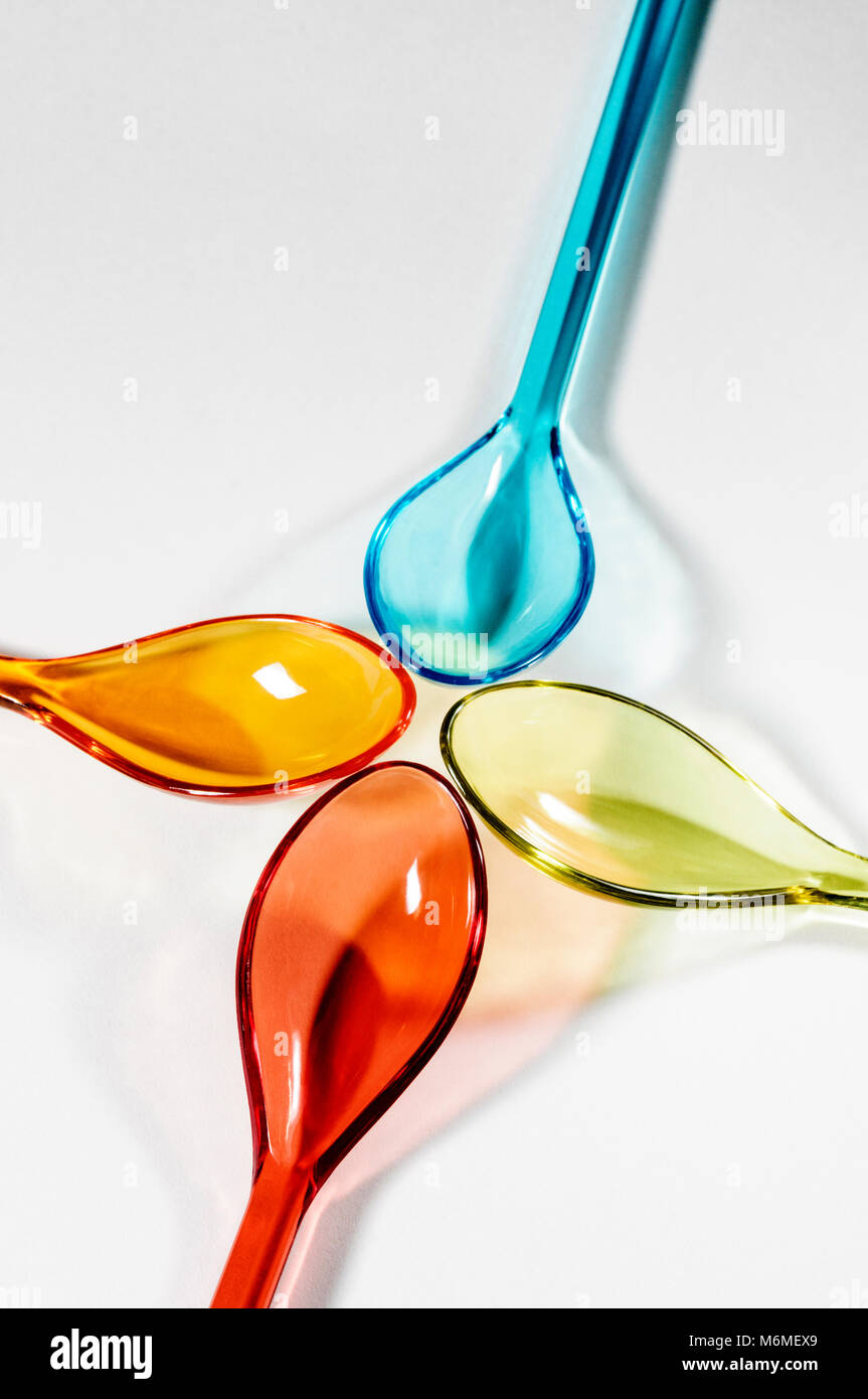 Four bright colourful desert spoons isolated on white background Stock ...