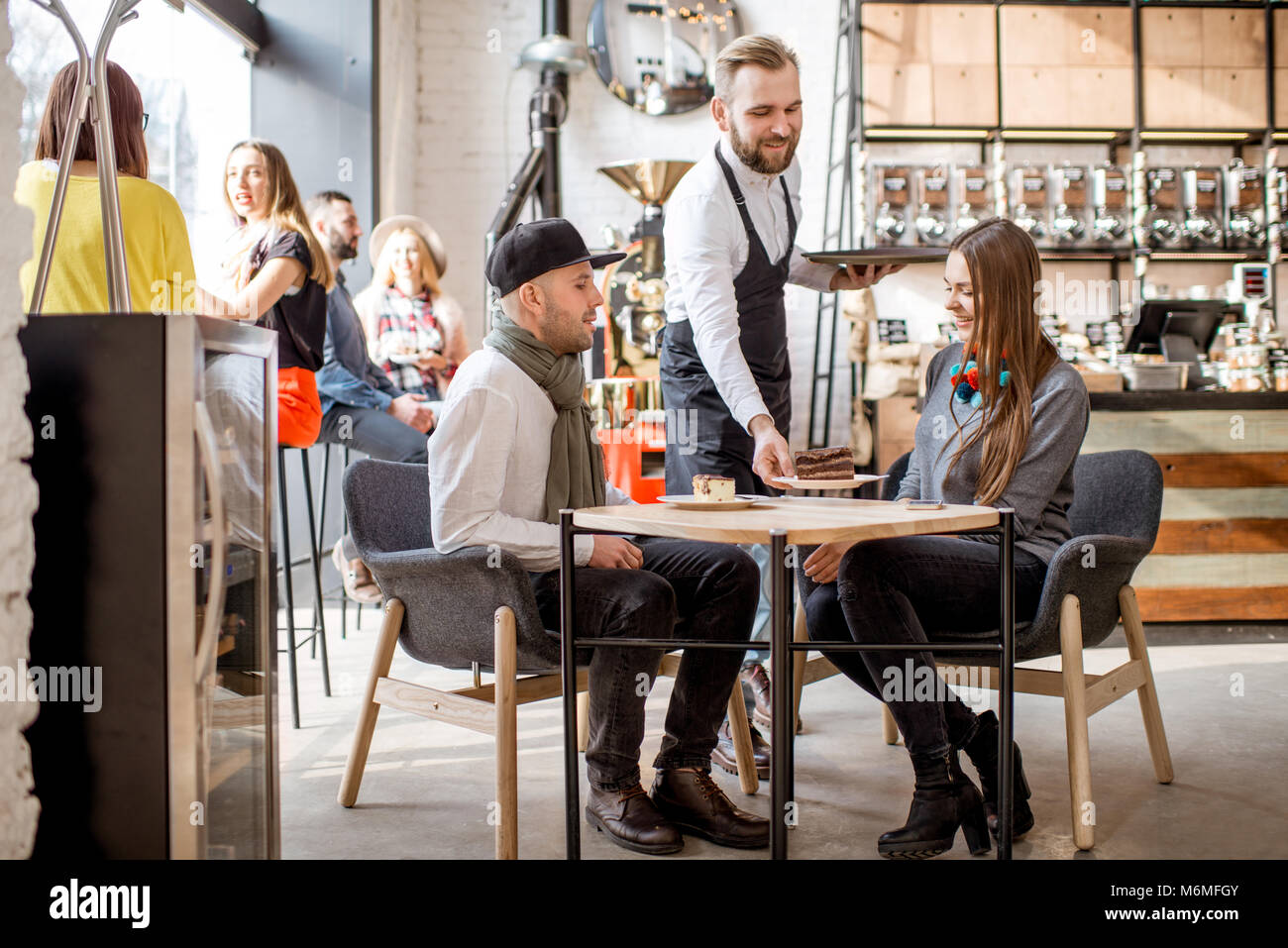 Couple ordering in the cafe Stock Photo - Alamy