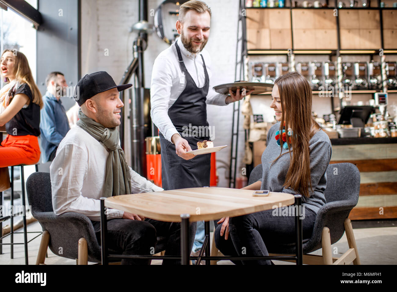 Couple ordering in the cafe Stock Photo - Alamy