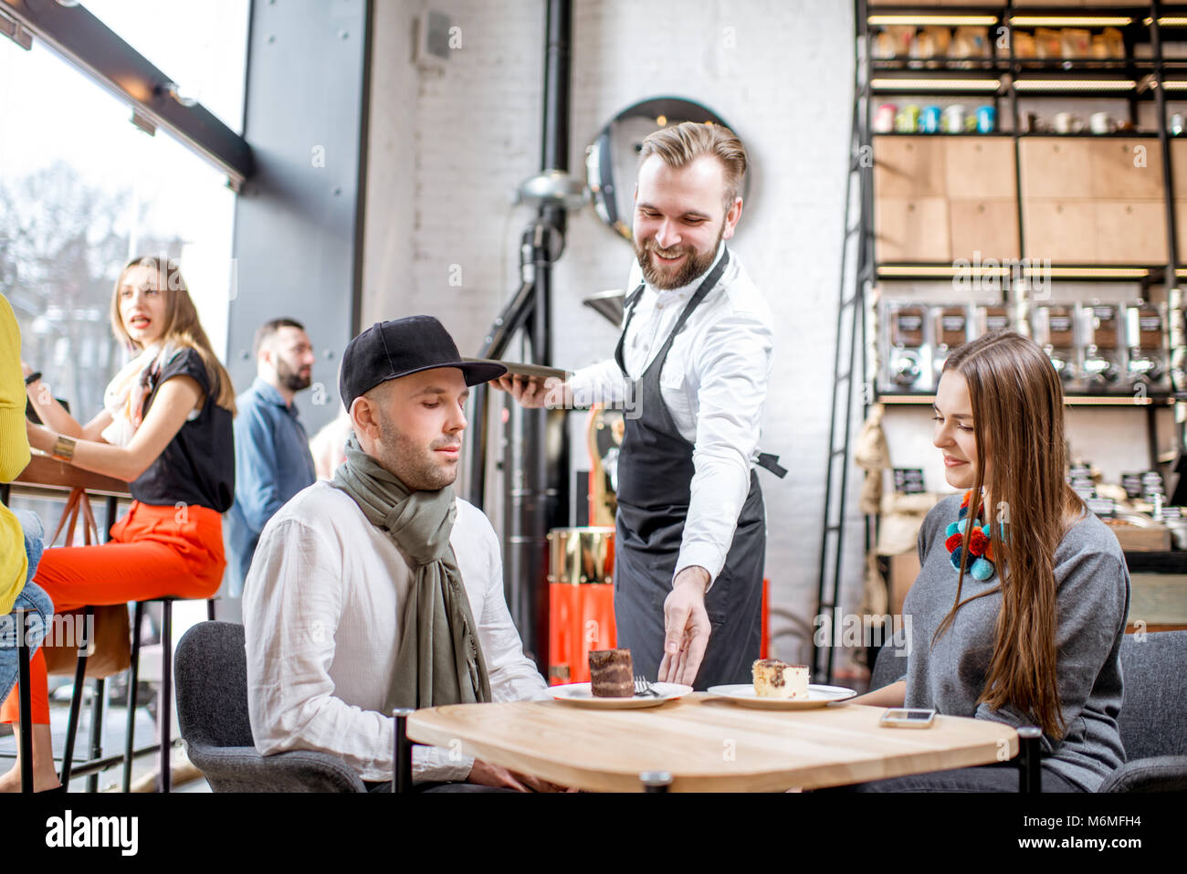 Couple ordering in the cafe Stock Photo - Alamy