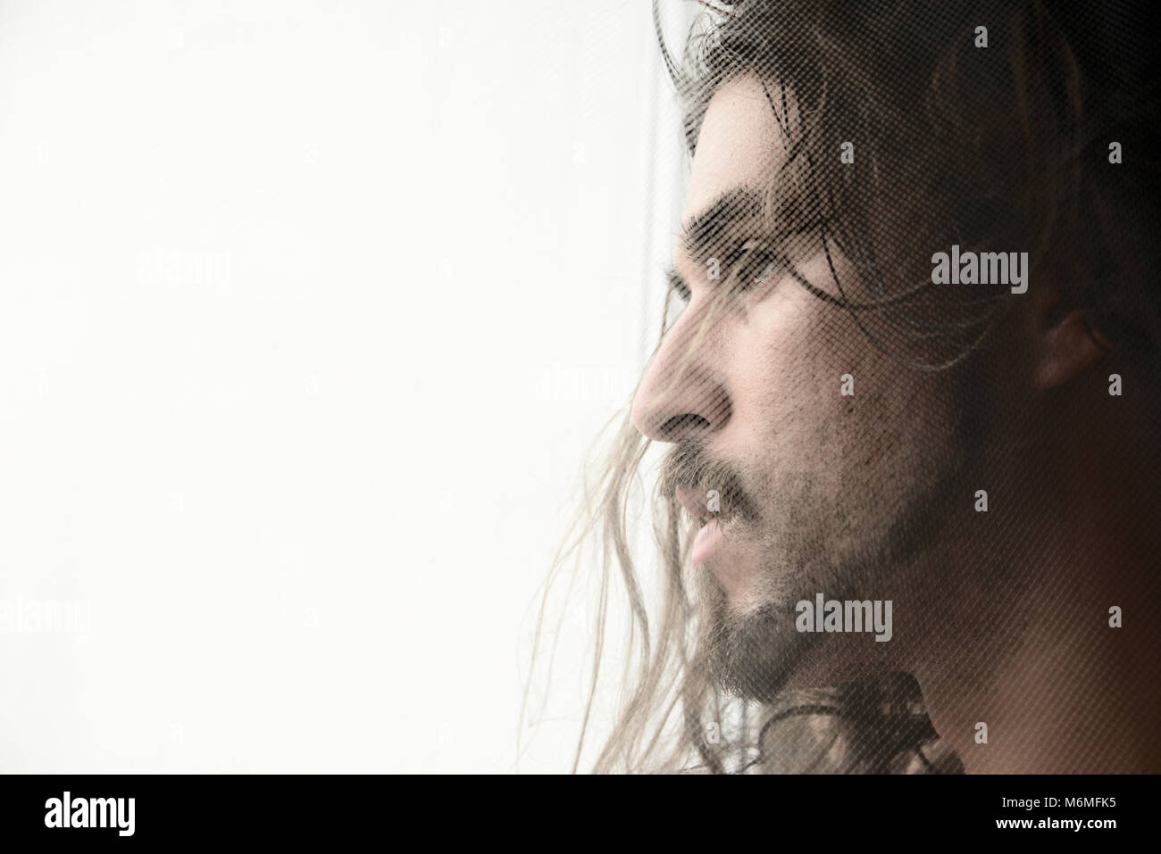 Handsome man with long hair profile Stock Photo - Alamy