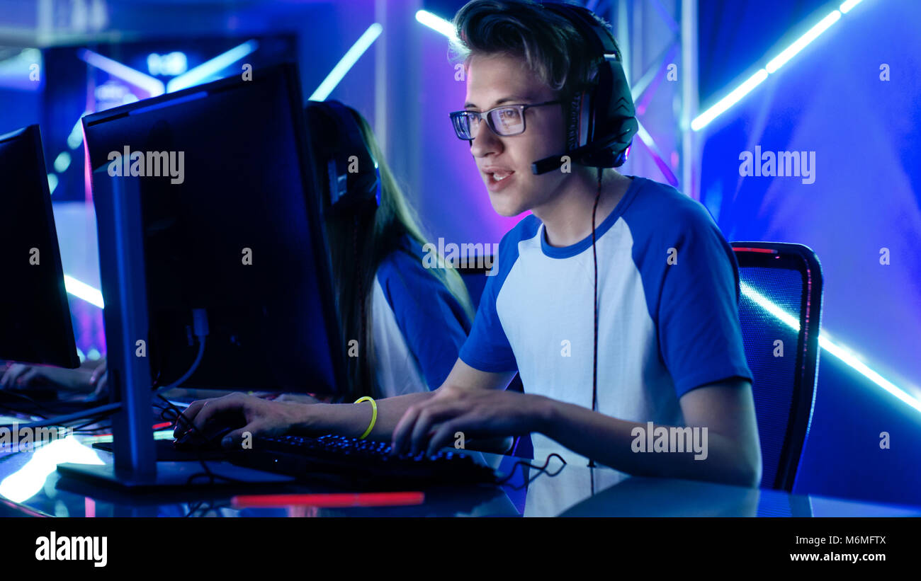Shot of a Teenage Gamer Team Captain Giving Commands into Microphone ...