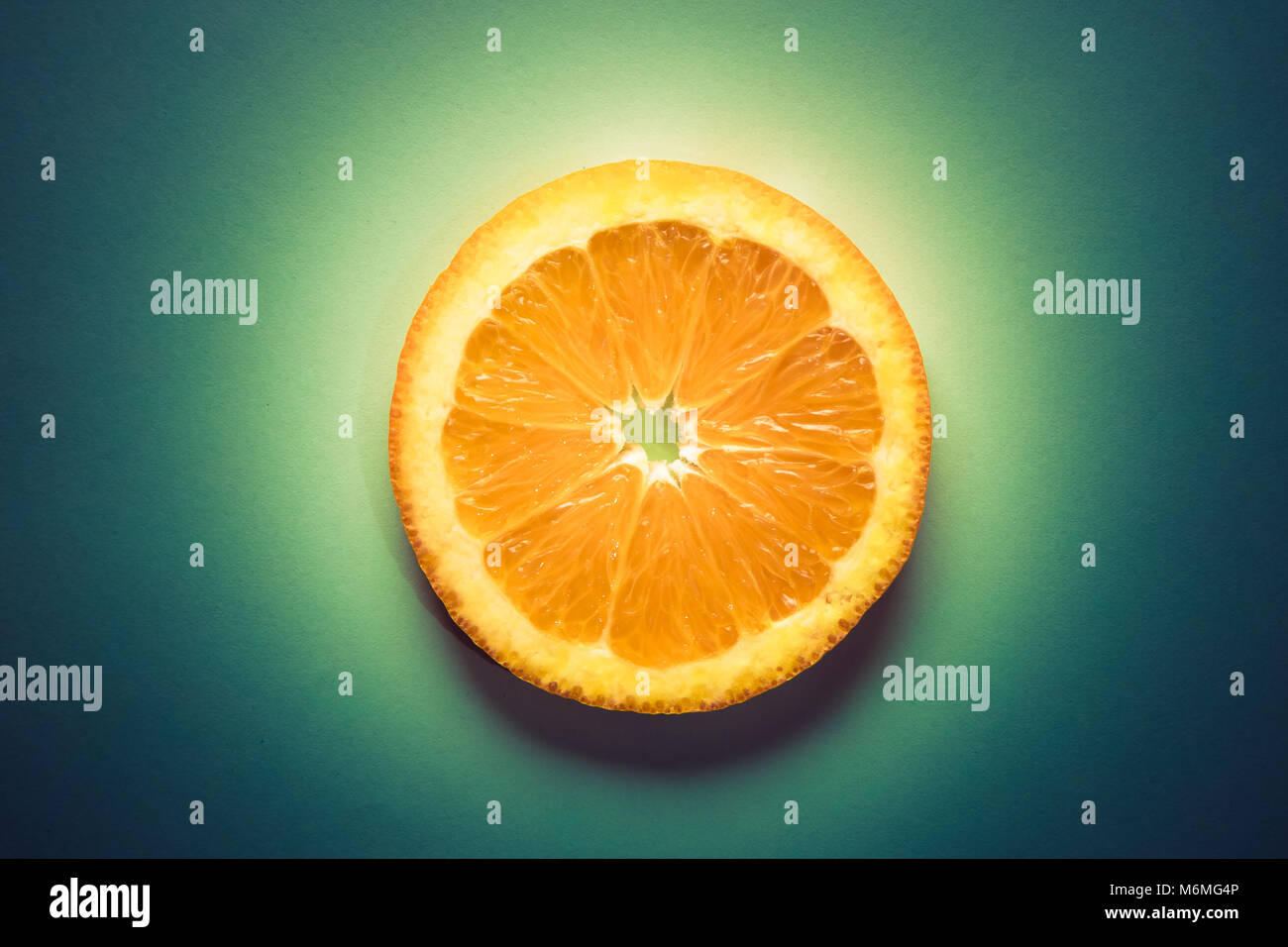 Orange slice on green background. High angle view. Minimal fruit ...