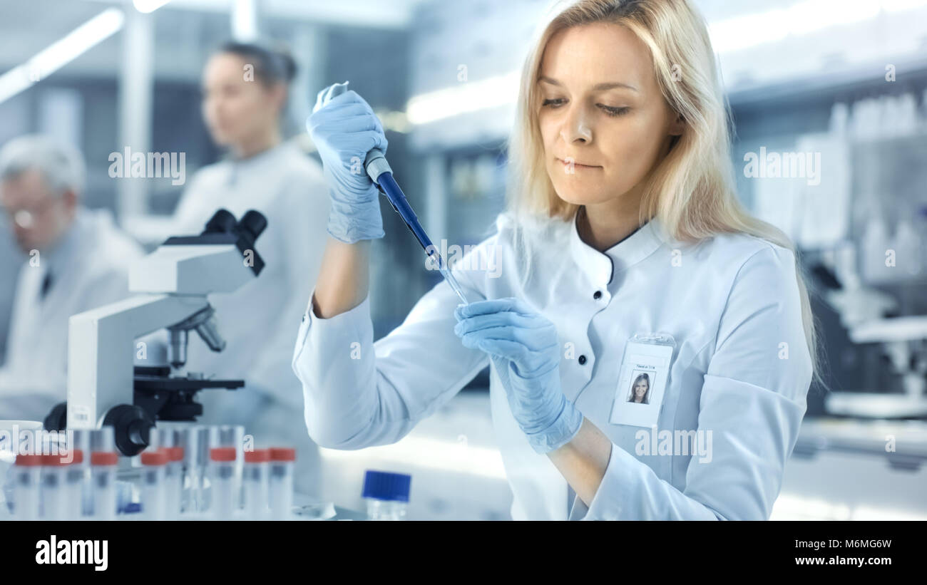 Female Research Scientist Uses Micropipette Filling Test Tubes ...