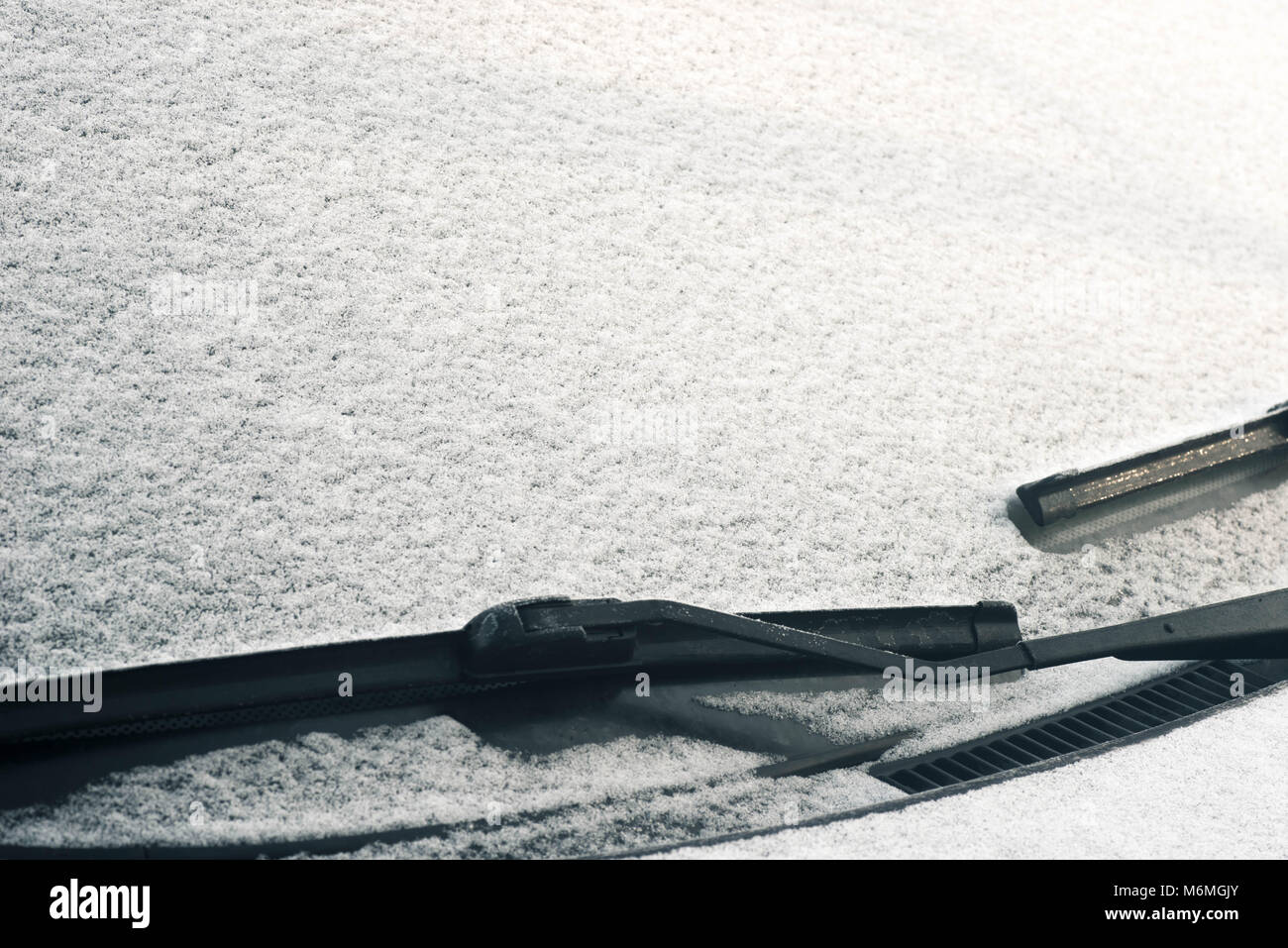 car's windscreen wiper covered in snow closeup Stock Photo - Alamy