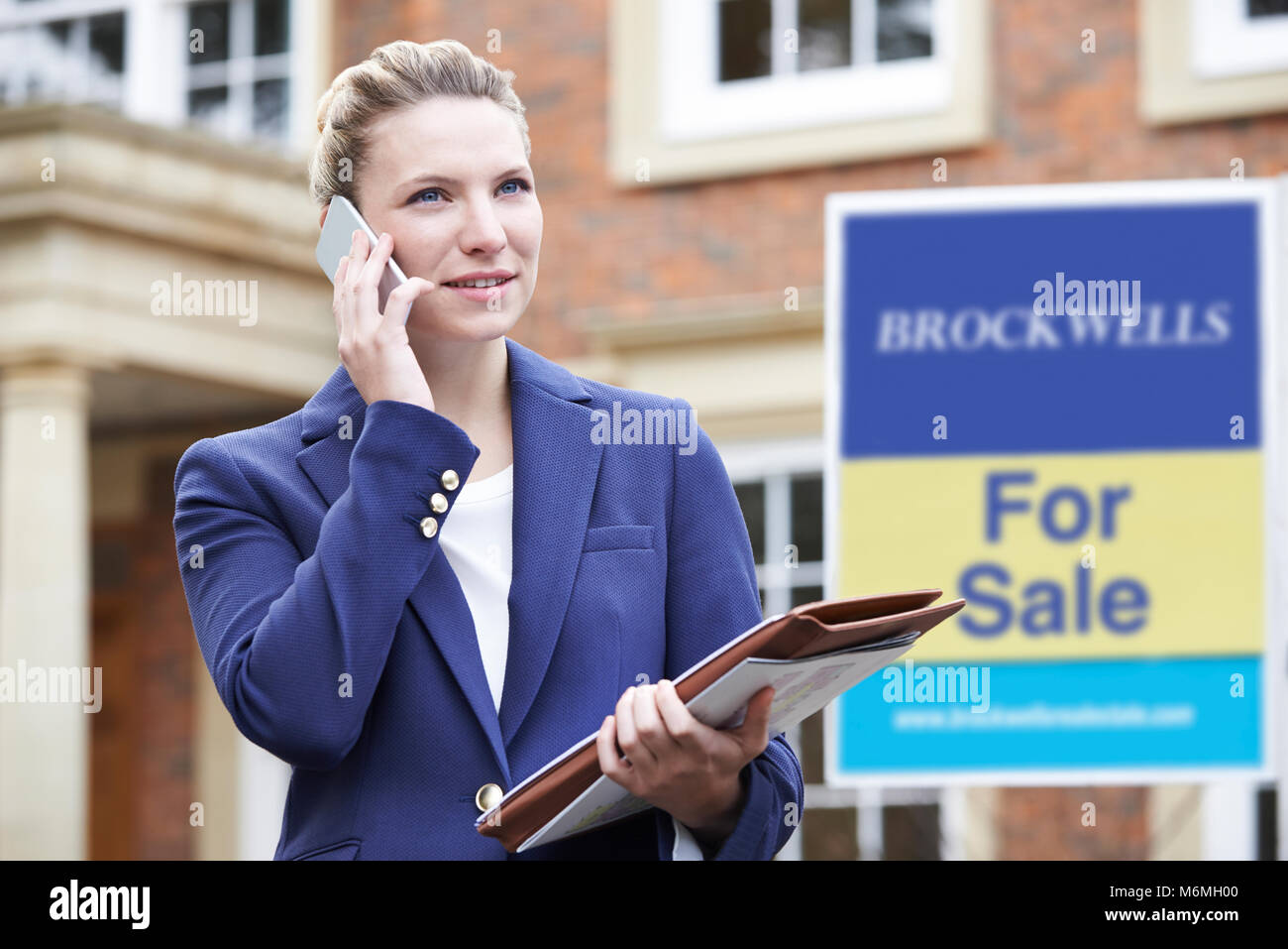 Attractive female real estate agent hi-res stock photography and images ...