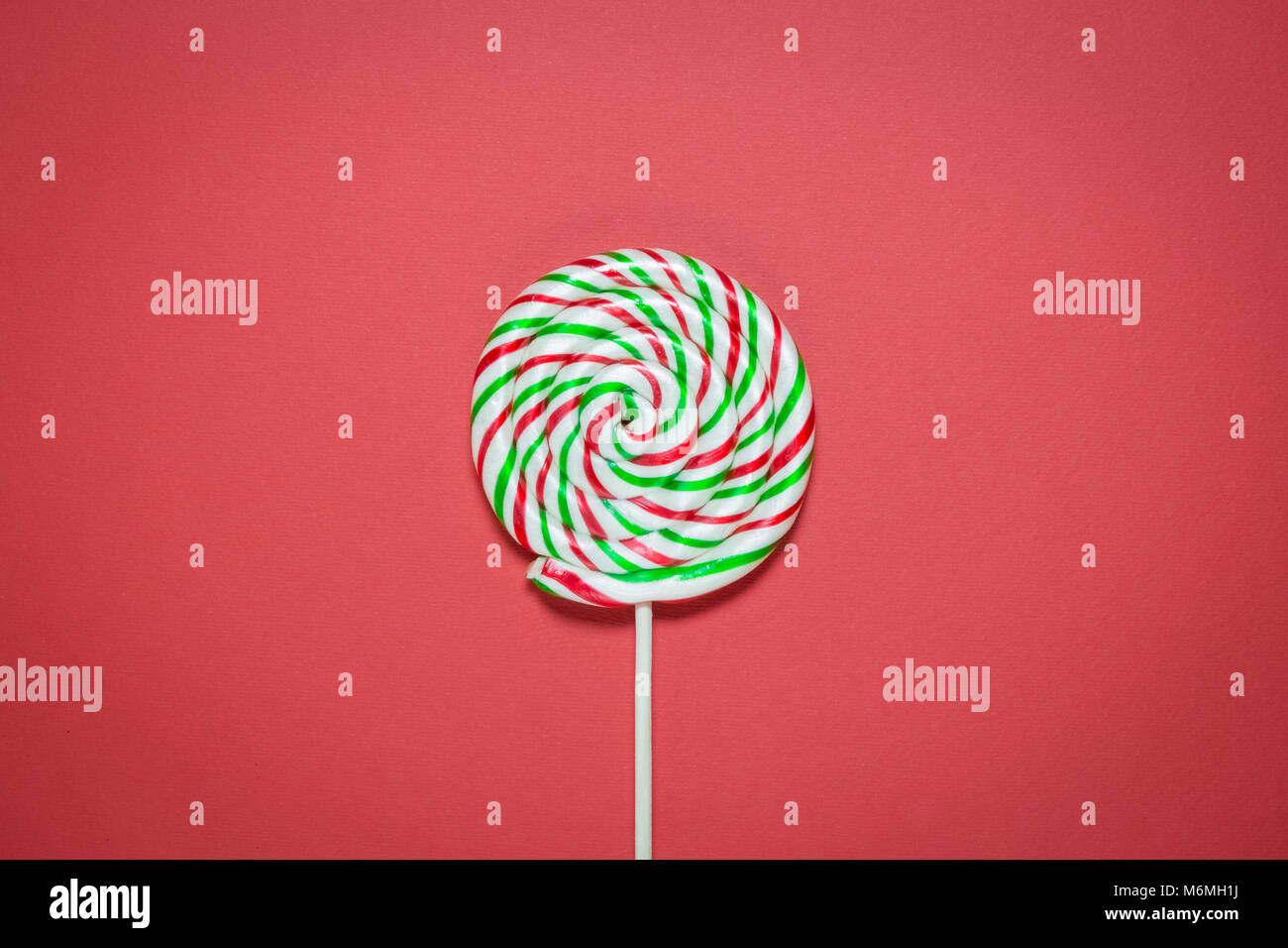 Lollipop on red background minimal concept Stock Photo - Alamy