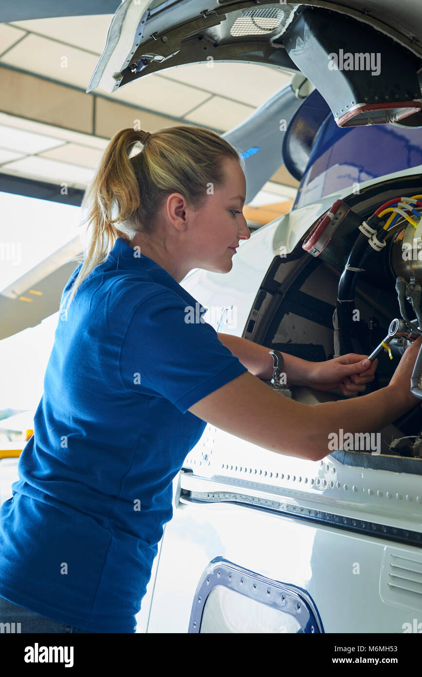 Female Aero Engineer Working On Helicopter In Hangar Stock Photo - Alamy