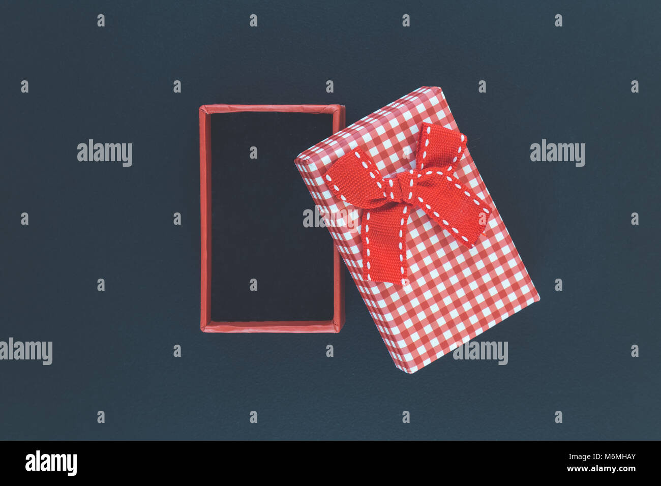 Top view of open empty gift box on black background. Space for product ...